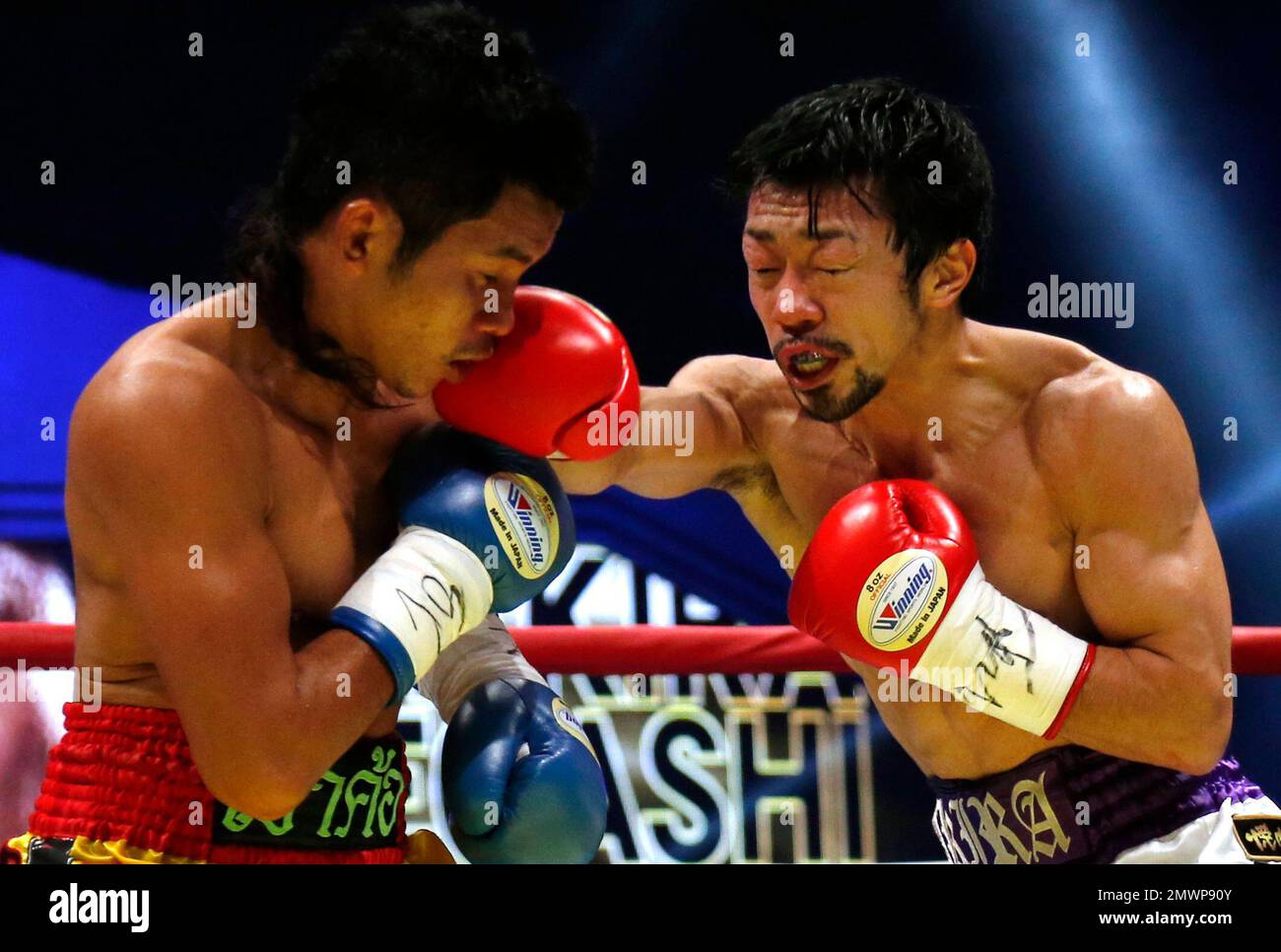 Japanese champion Akira Yaegashi, right, sends a right to Thai ...