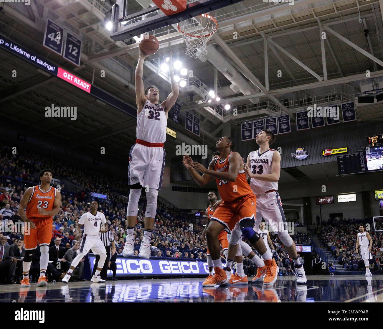 Gonzaga forward Zach Collins (32) shoots in front of teammate forward ...