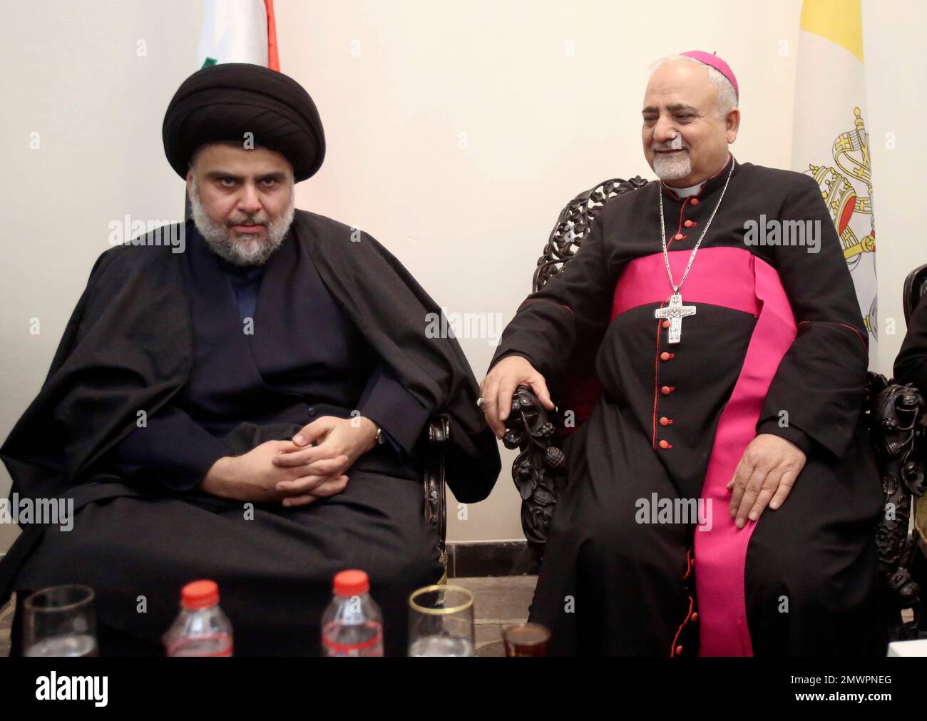 Influential Iraqi Shiite cleric Muqtada al-Sadr, left, sits with Bishop ...