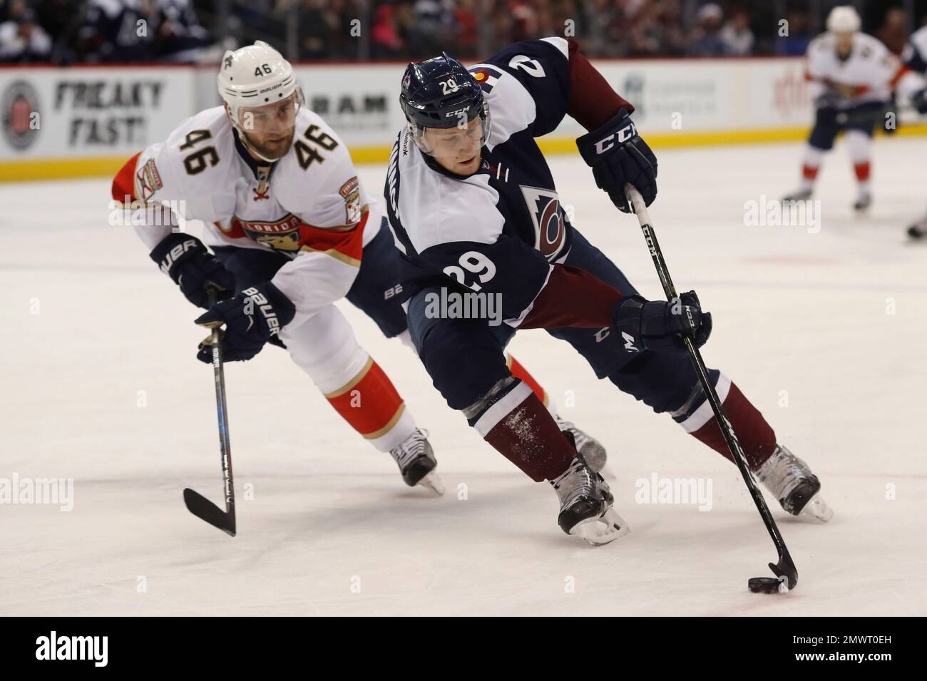 Colorado Avalanche center Nathan MacKinnon, right, takes a shot as ...