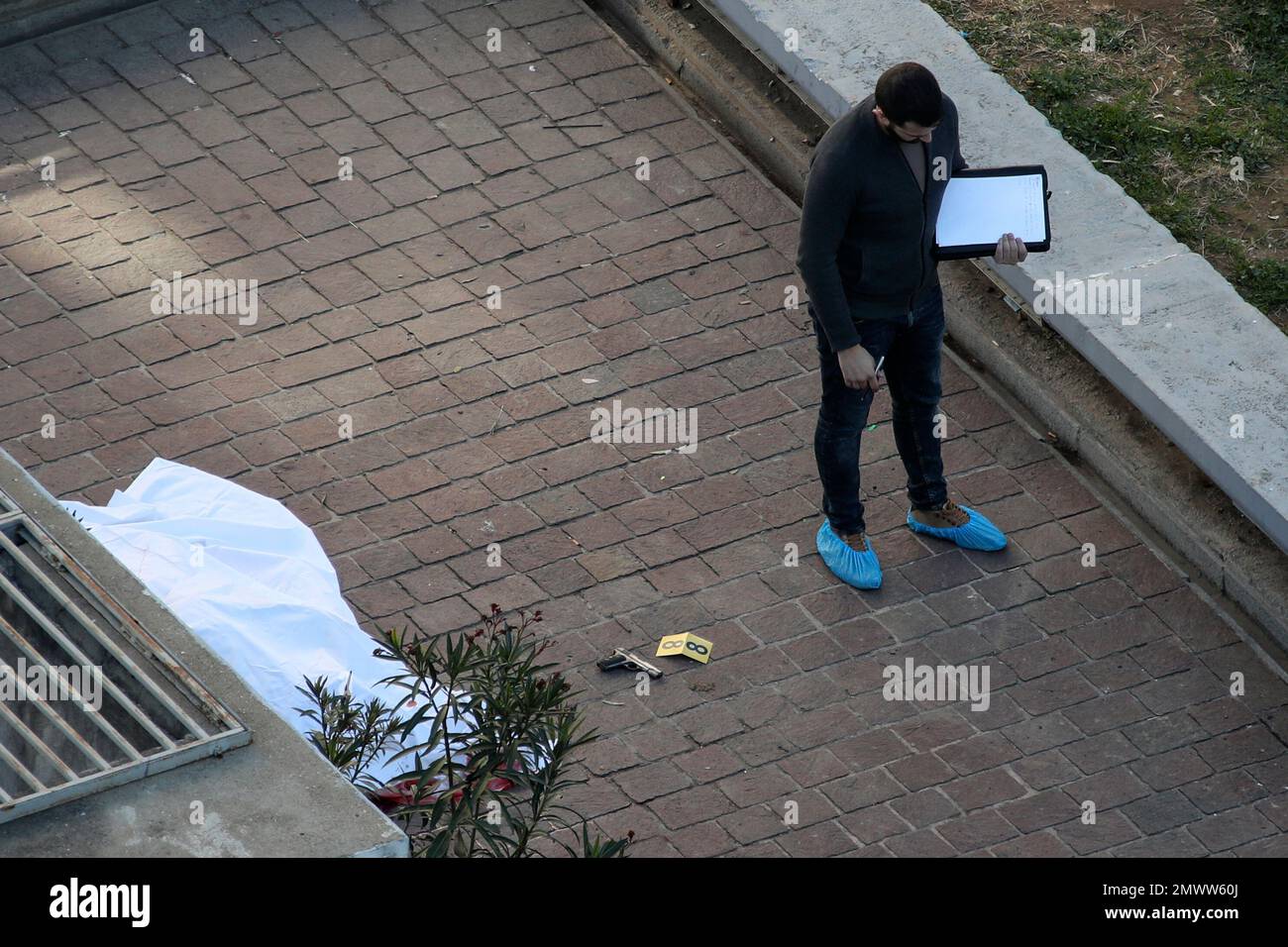 ADDING AND UPDATING DETAILS - Greek plain clothed policemen stands over ...