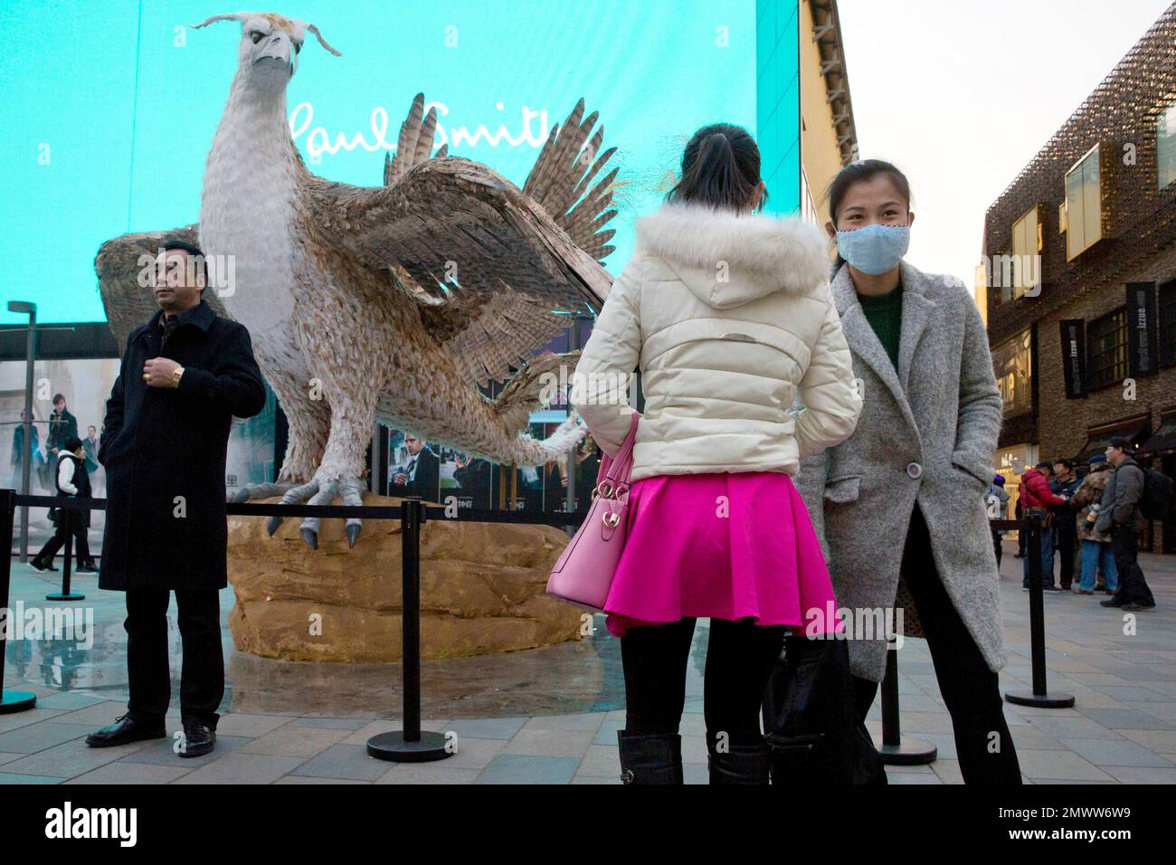 Shoppers at a mall look over a life size replica of a creature from the ...