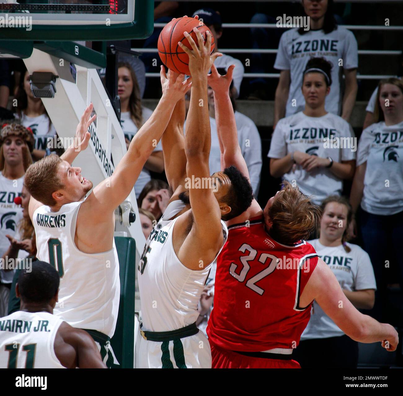 Michigan State's Kyle Ahrens (0) and Kenny Goins, center, and ...