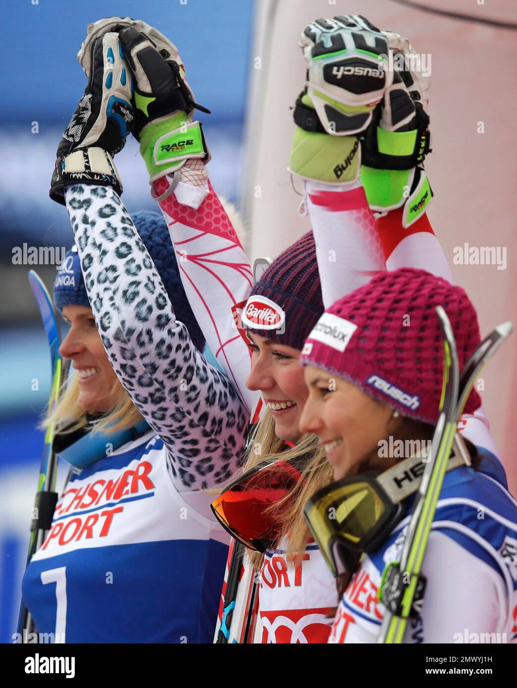 Mikaela Shiffrin, of the United States, center, raises her arms as she ...