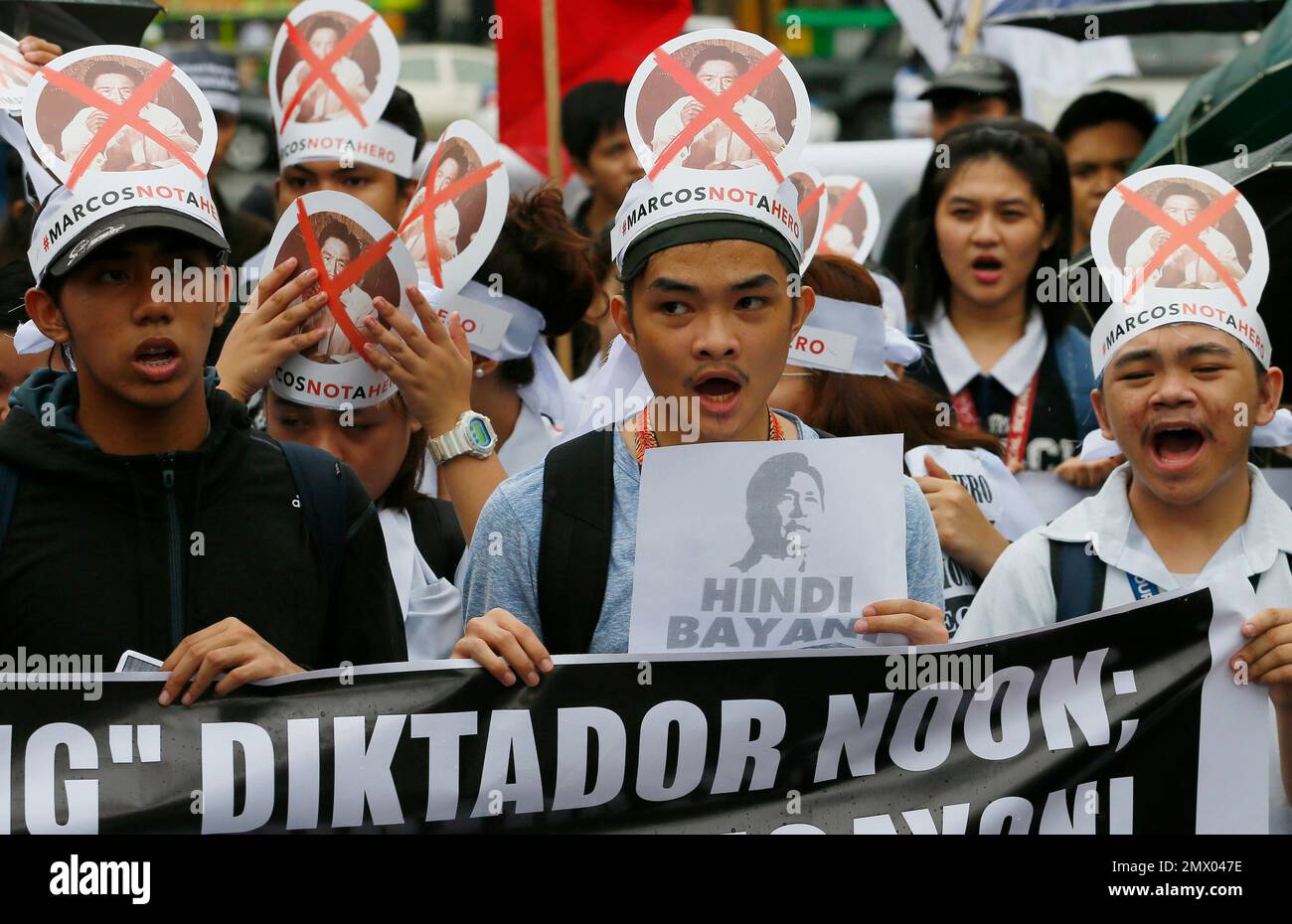 Students shout slogans as they burn an effigy of the late Philippine ...
