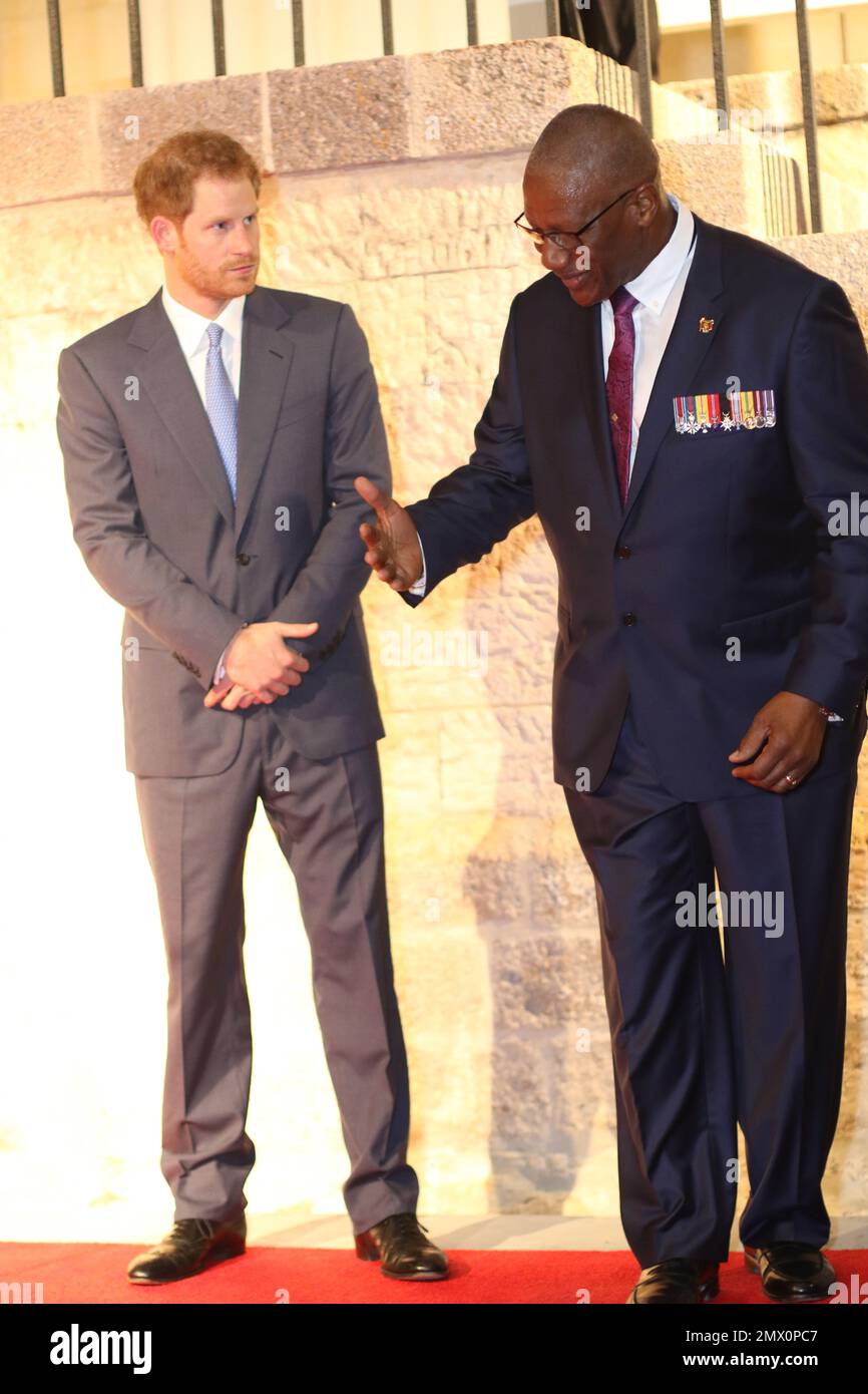 Britain's Prince Harry, left, listens to Governor-General of Antigua ...