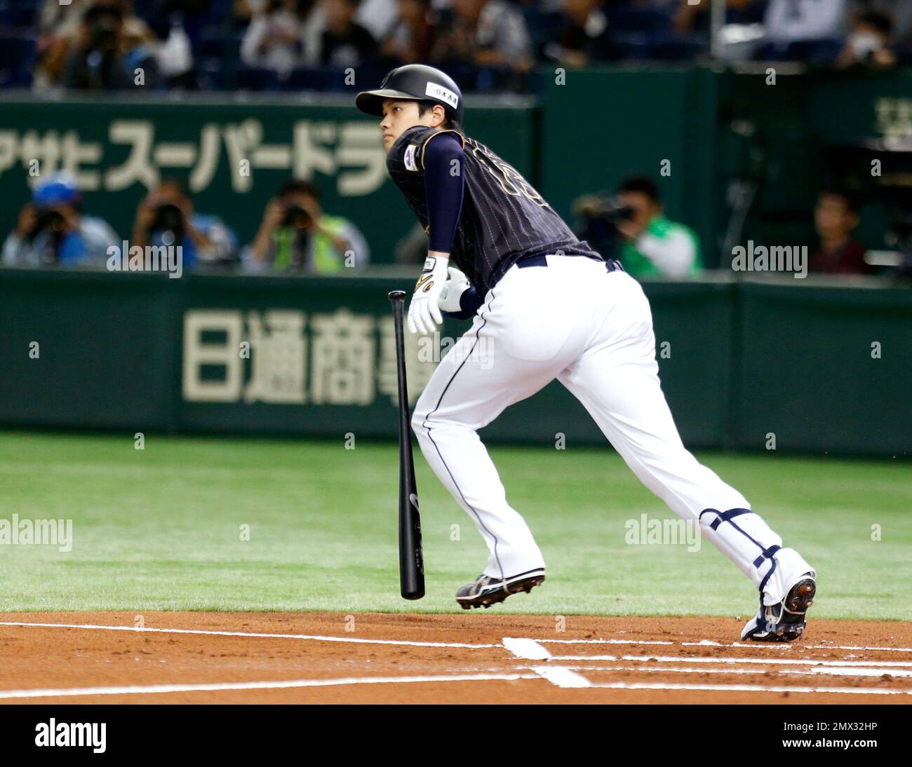 Japan's designated hitter Shohei Otani heads to first as he hits a ...