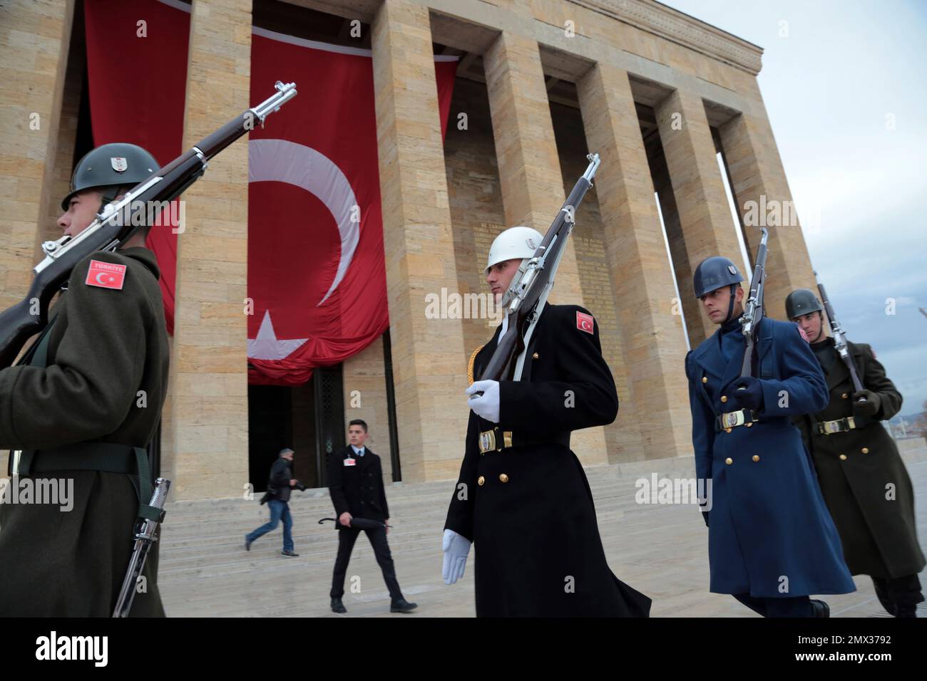 Military honour guard parade as thousands of students and citizens walk to his mausoleum to ...