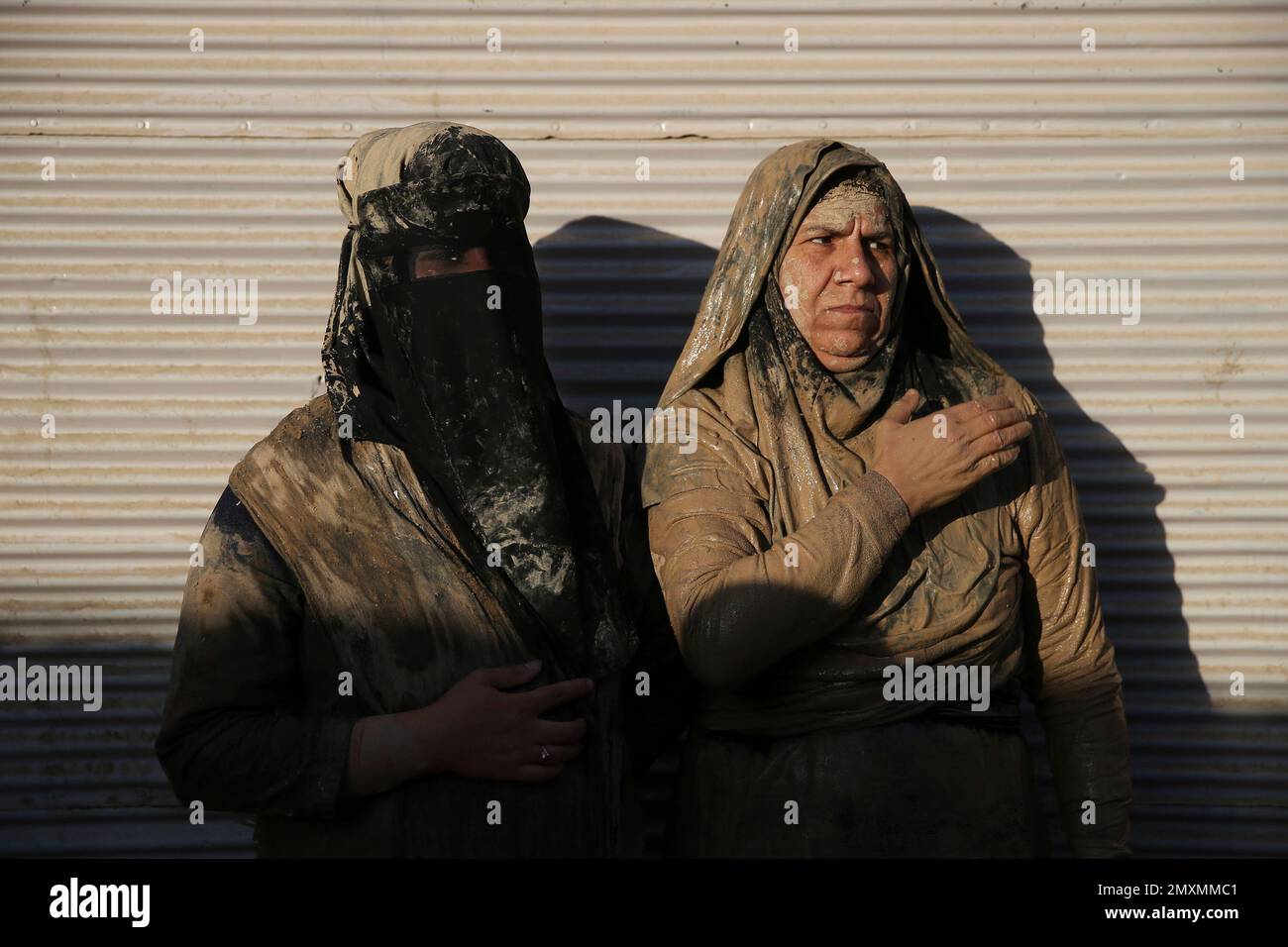 Iranian Shiite Muslims mourn after covering themselves with mud during ...