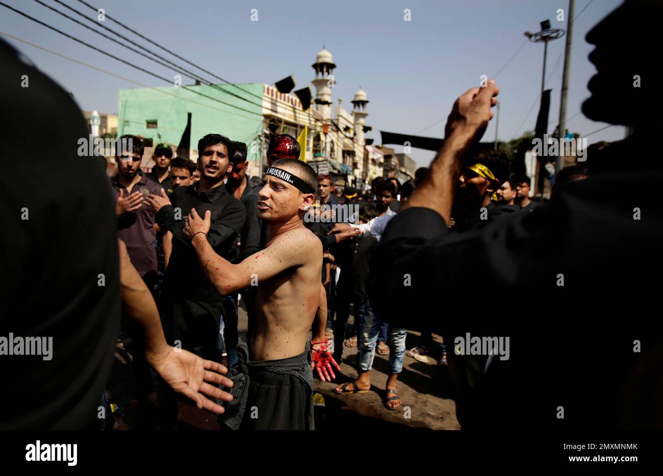 Indian Shiite Muslims beat their chests during a procession to mark ...