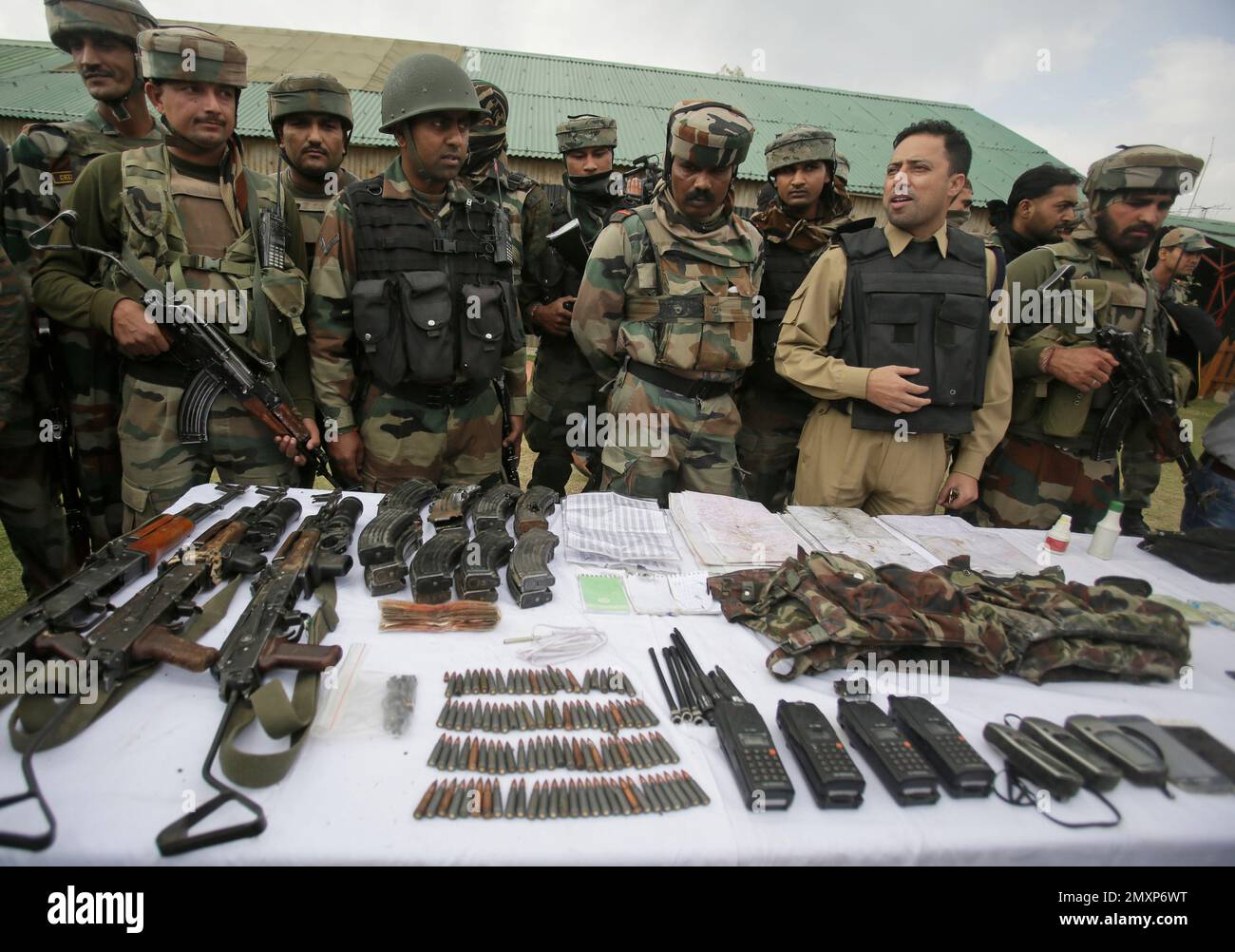 Indian Army soldiers display arms and ammunition recovered with the ...