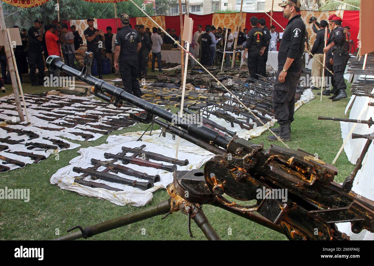 Pakistani police officers gather around the display of huge quantity of ...