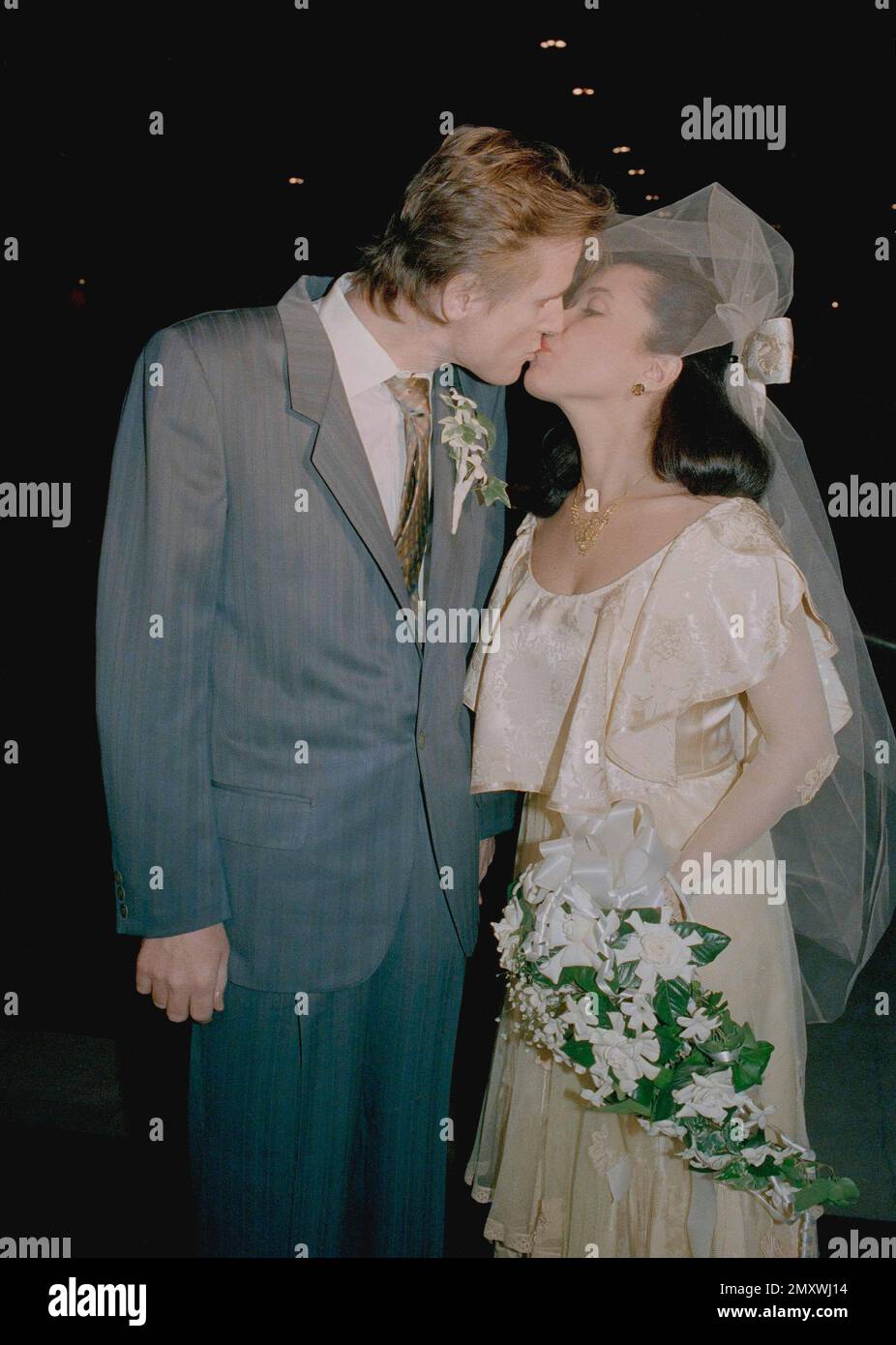 David Hefner, left, who is dying of AIDS, kisses his bride, Maria ...