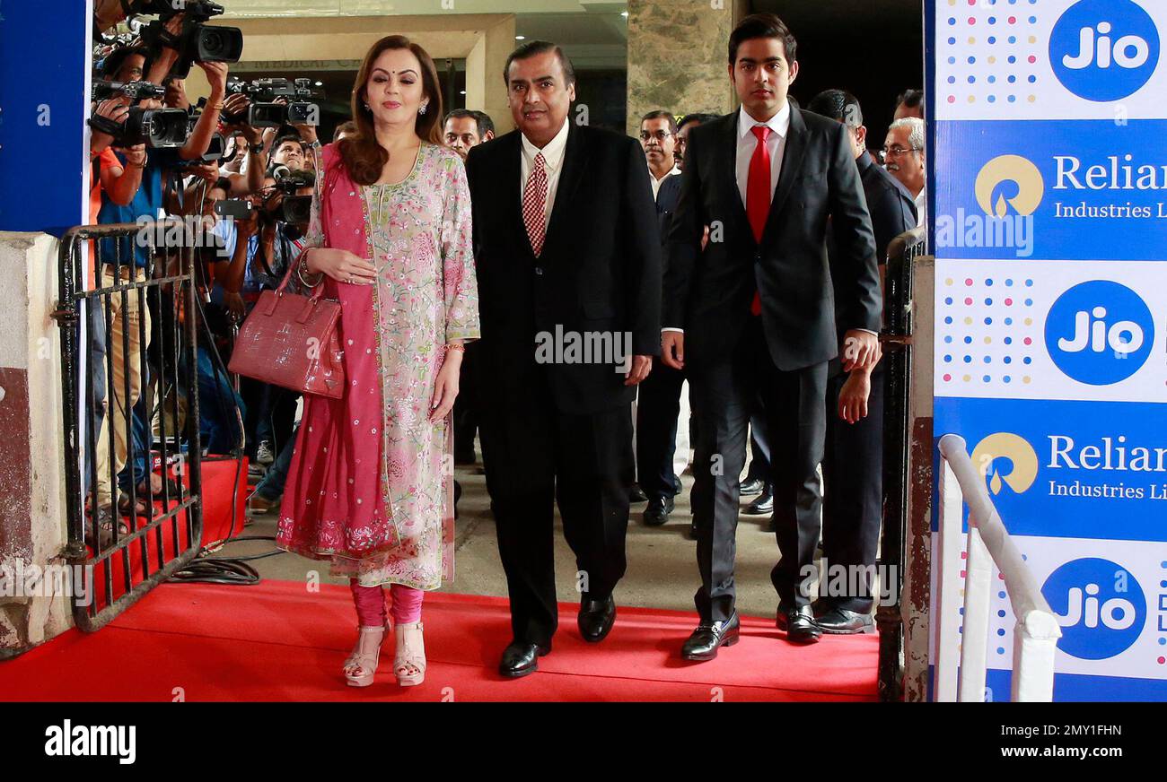 Reliance Industries Chairman Mukesh Ambani, center, his wife Nita Ambani and son Akash Ambani ...