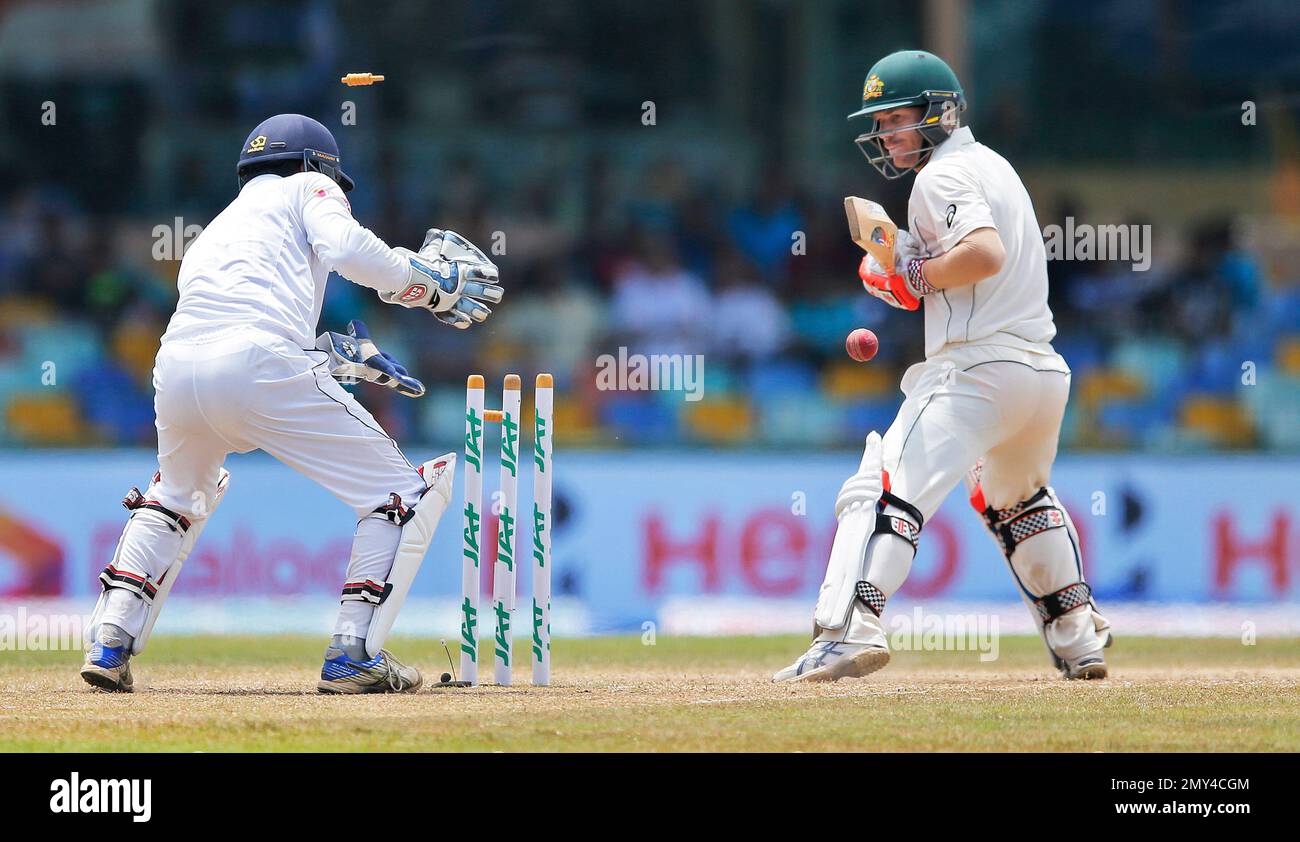 Australian cricketer David Warner is bowled as Sri Lankan wicket-keeper ...