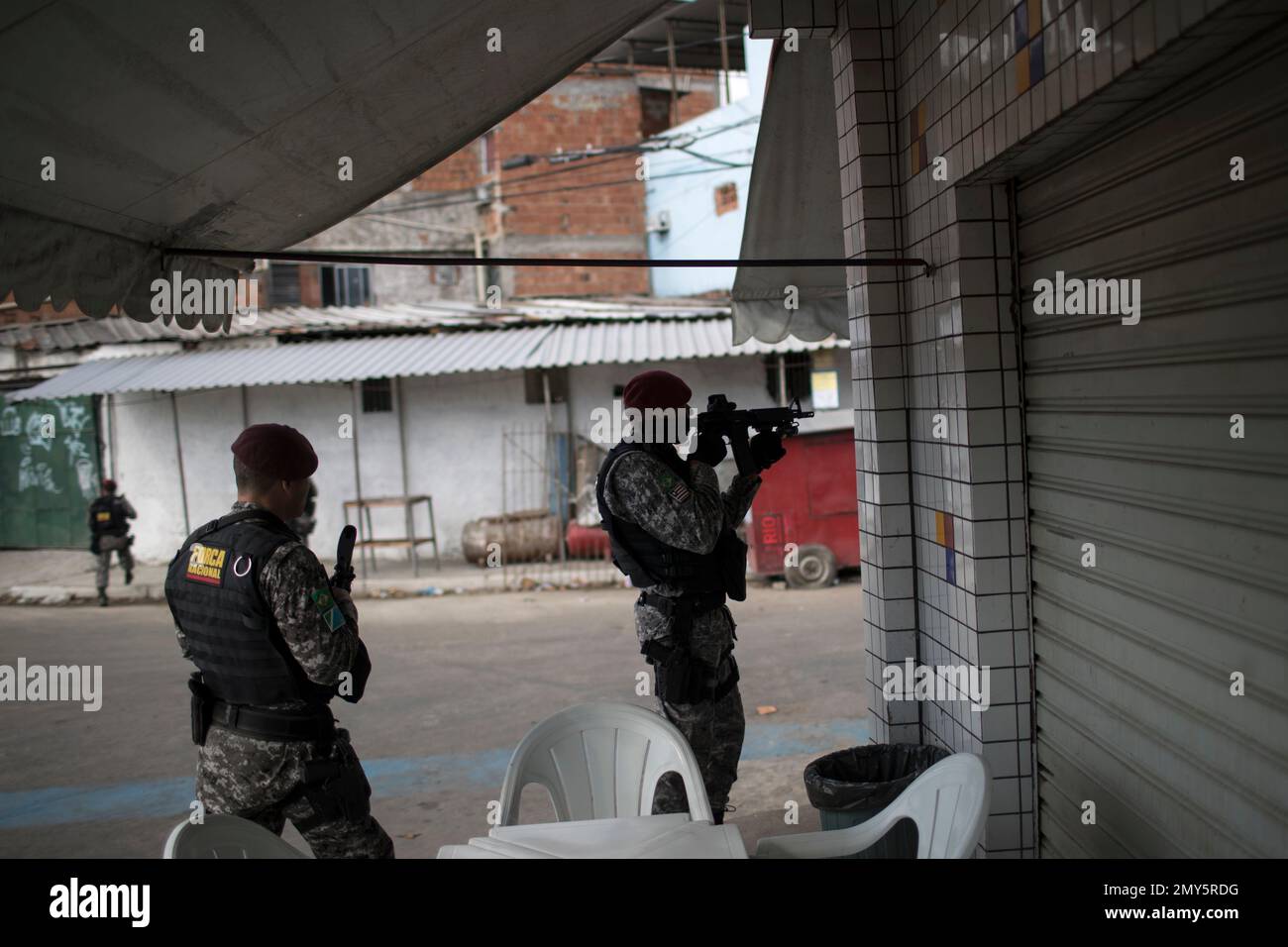 Brazil's national security force officers move inside the Vila do Joao ...