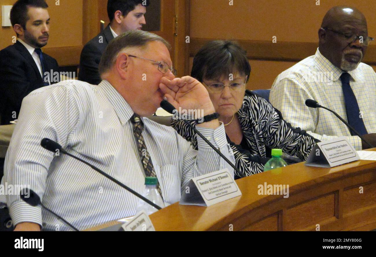 Kansas state Rep. Dan Hawkins, left, R-Wichita, confers with Sen. Laura ...