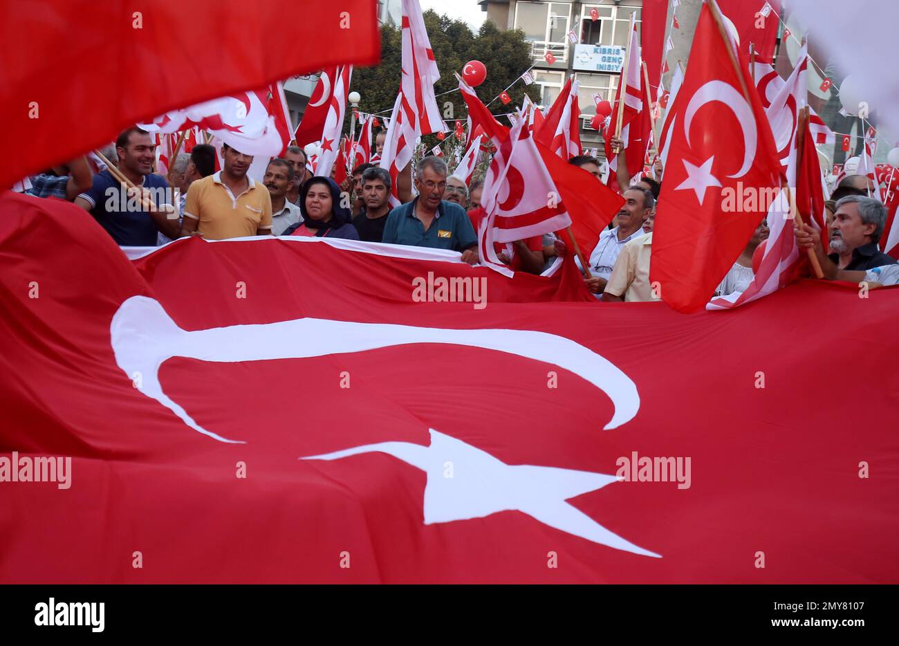 Turkish Cypriot demonstrators wave Turkish and Turkish Cypriot flags ...