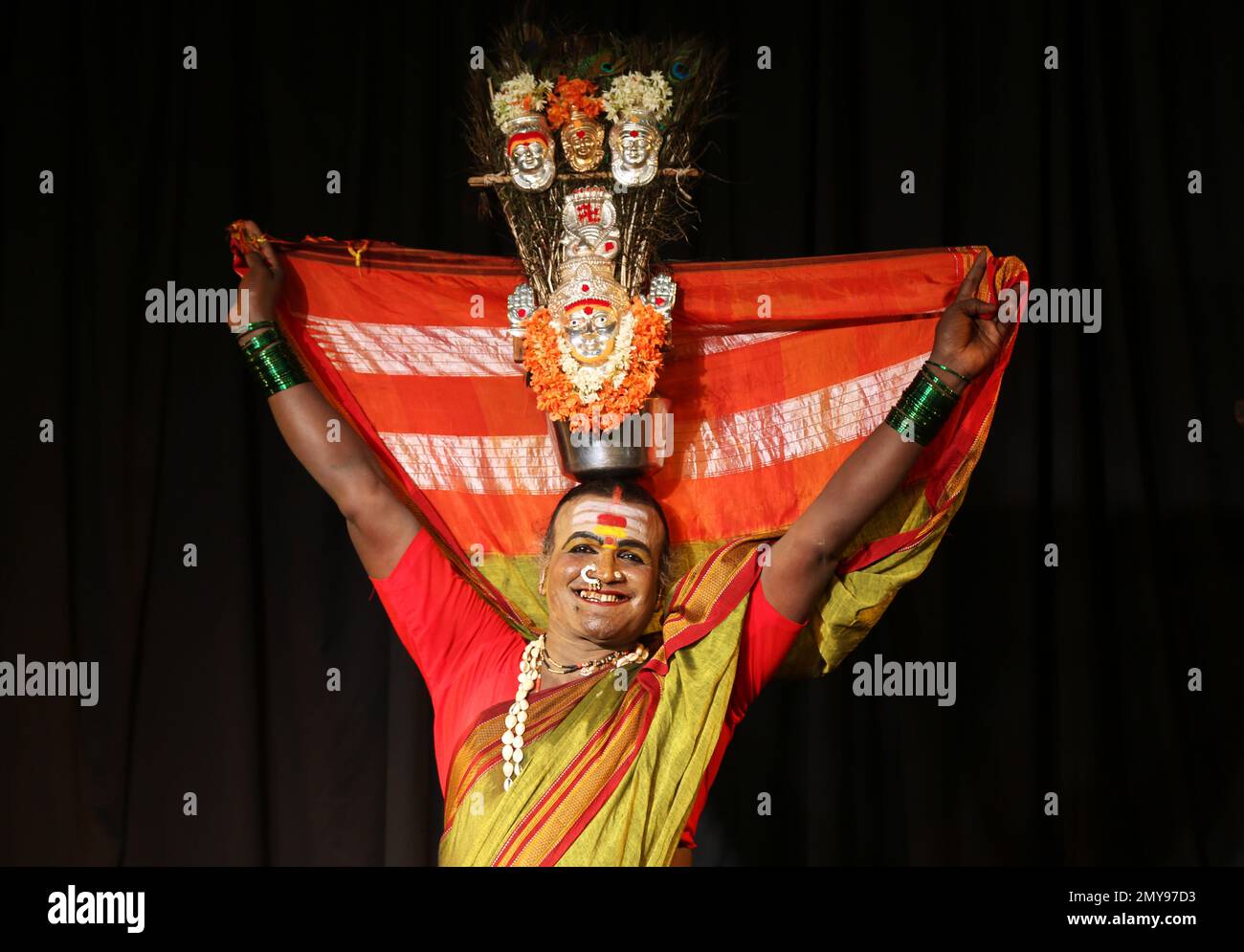 An Indian transgender B. Manjamma Jogathi carries a vessel with images ...