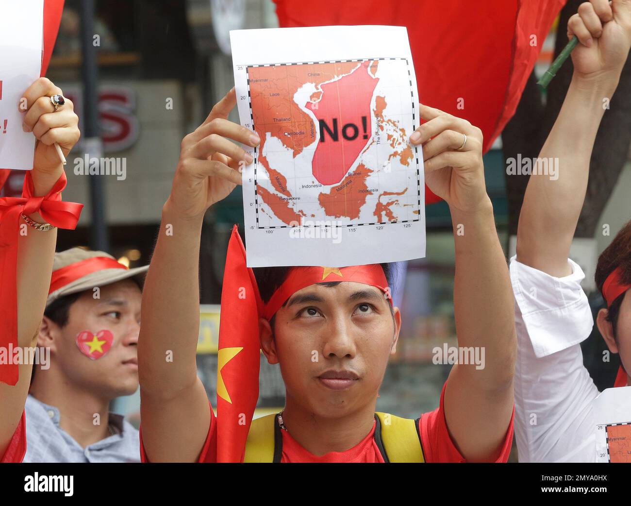 A Vietnamese protester showing a map of the South China Sea marked with ...