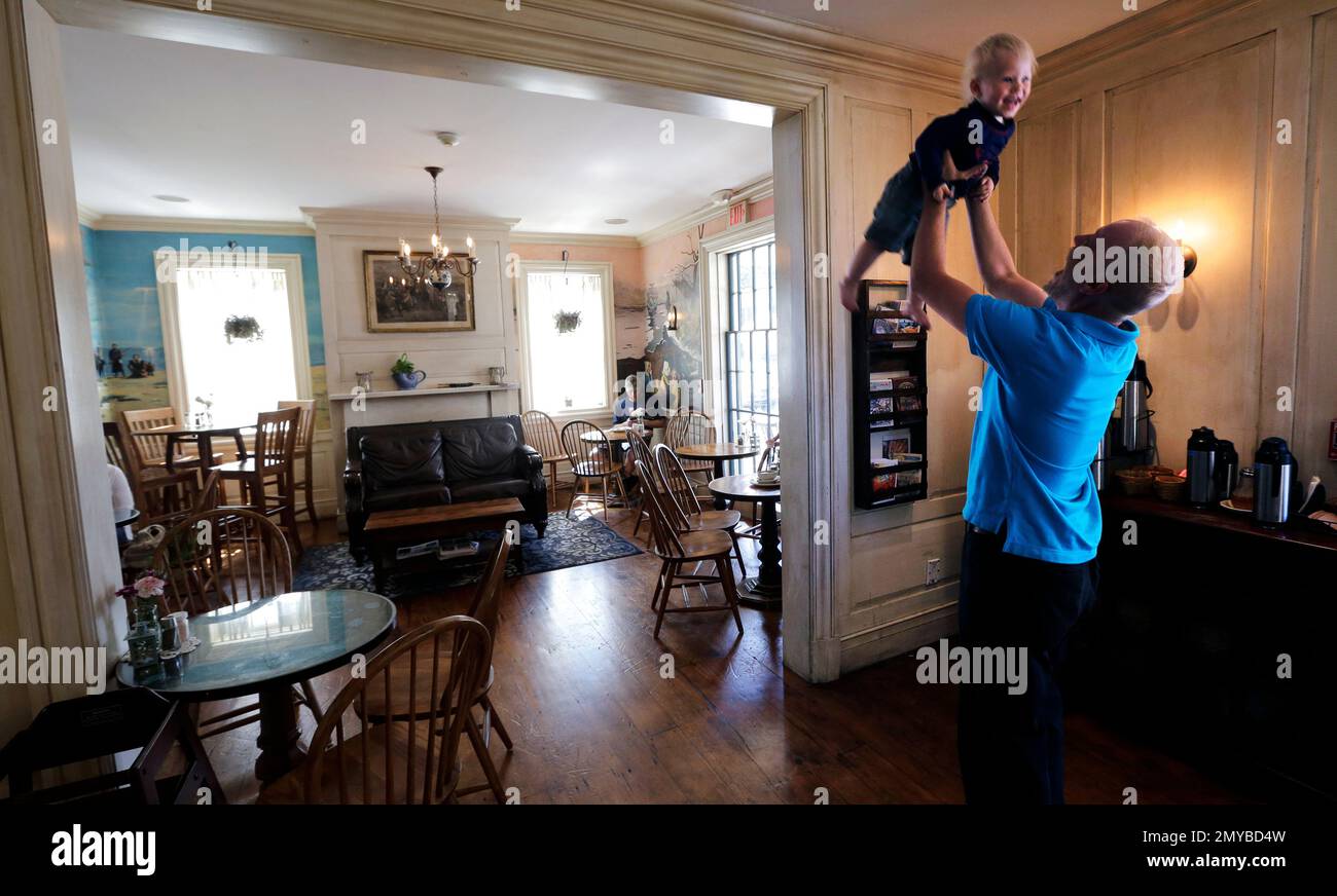 Craig Sander, of Plymouth, Mass., tosses his thirteen-month-old son ...