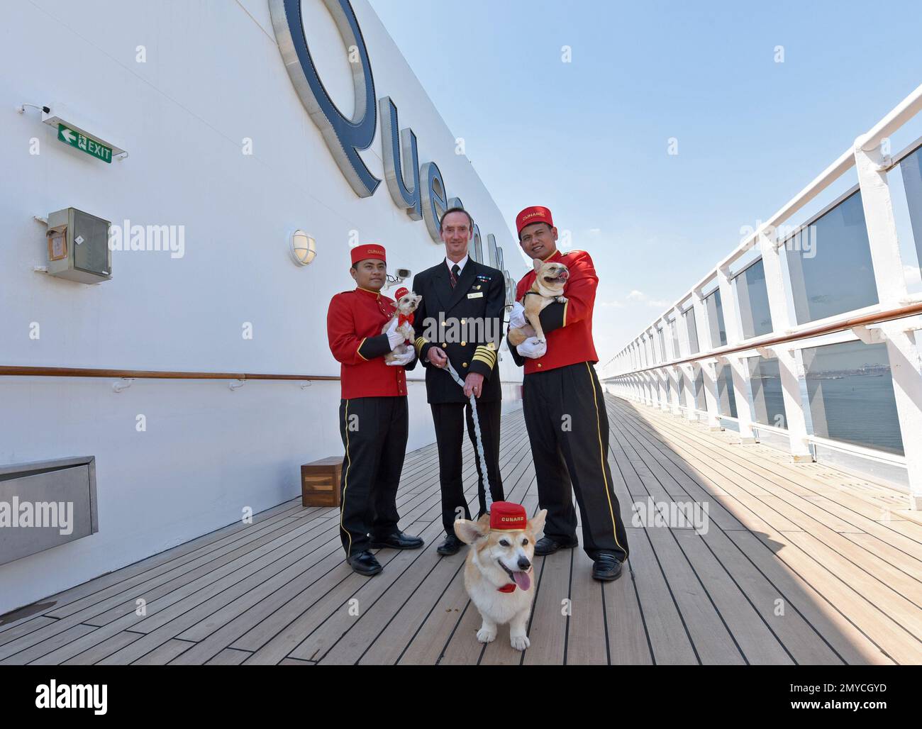 IMAGE DISTRIBUTED FOR CUNARD - Captain Christopher Wells, center, with ...