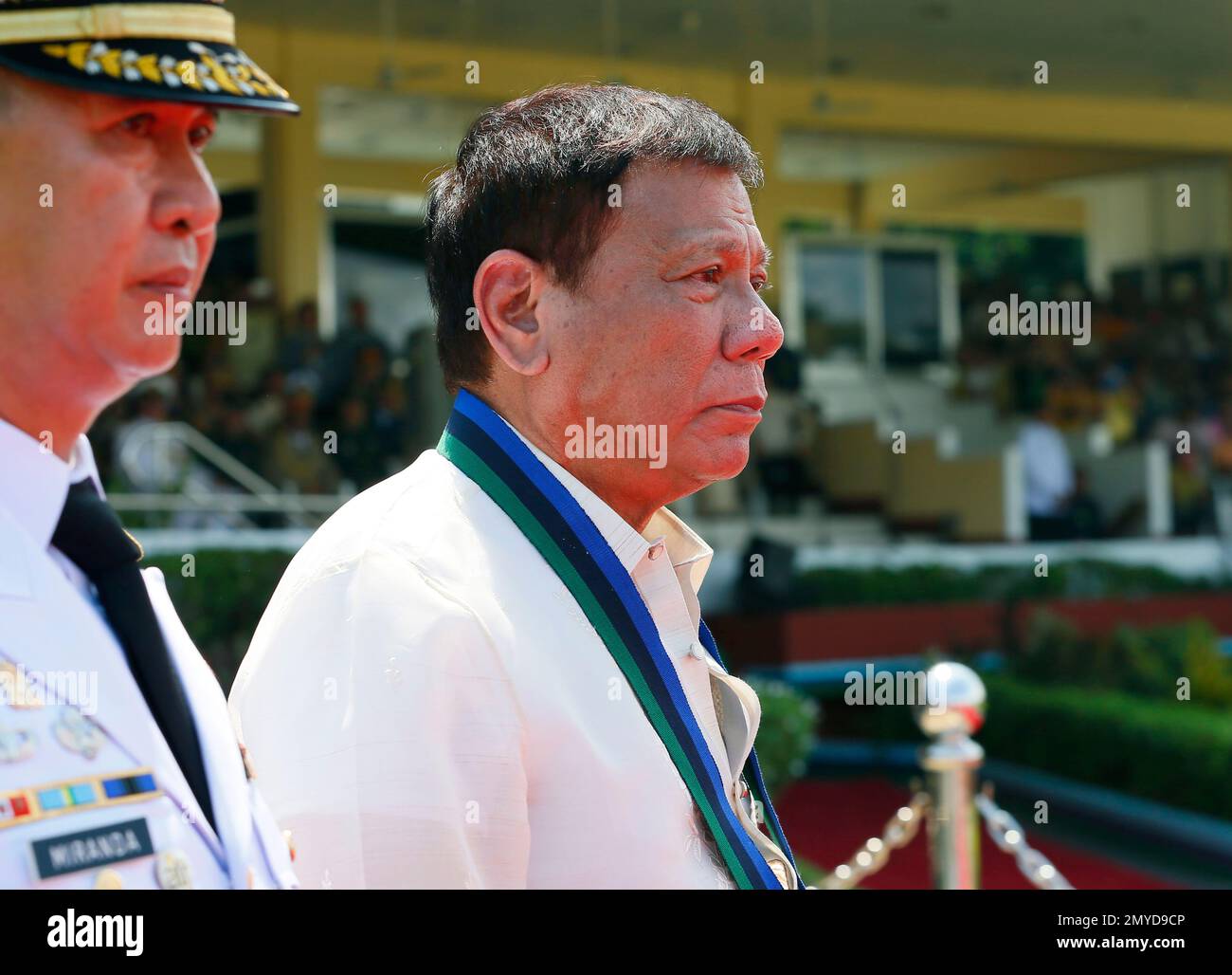 Philippine President Rodrigo Duterte, right, walks towards his vehicle ...