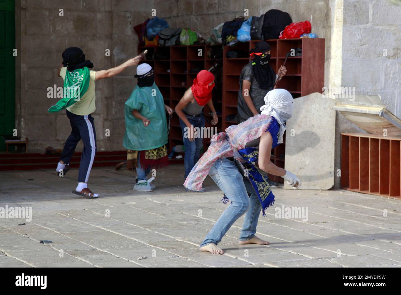 Palestinian youth throw stones at Israeli border police during clashes ...