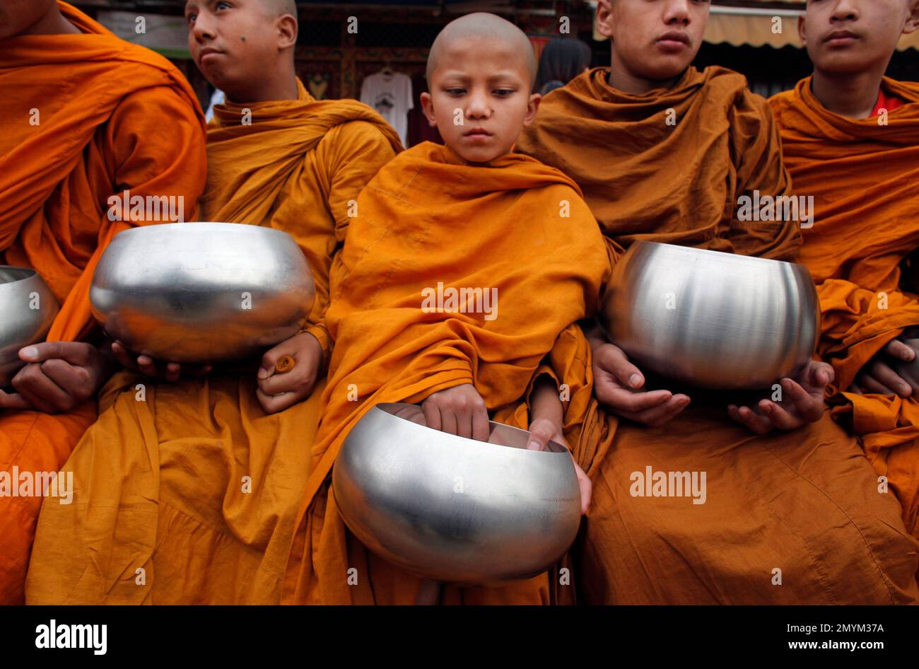 Novice Buddhist monks wait for alms during Buddha Jayanti, or Buddha ...