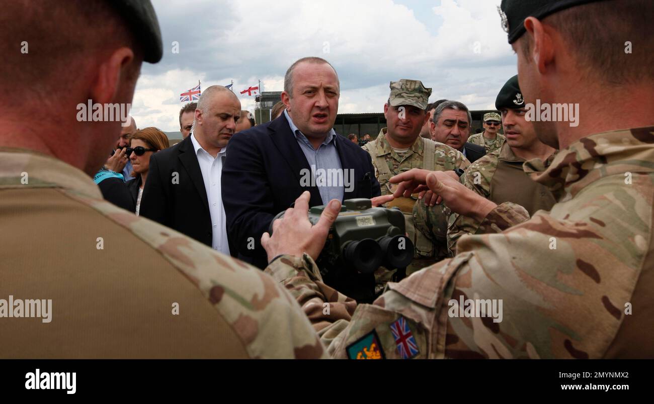 Georgian President Giorgi Margvelashvili, center, visits British troops ...