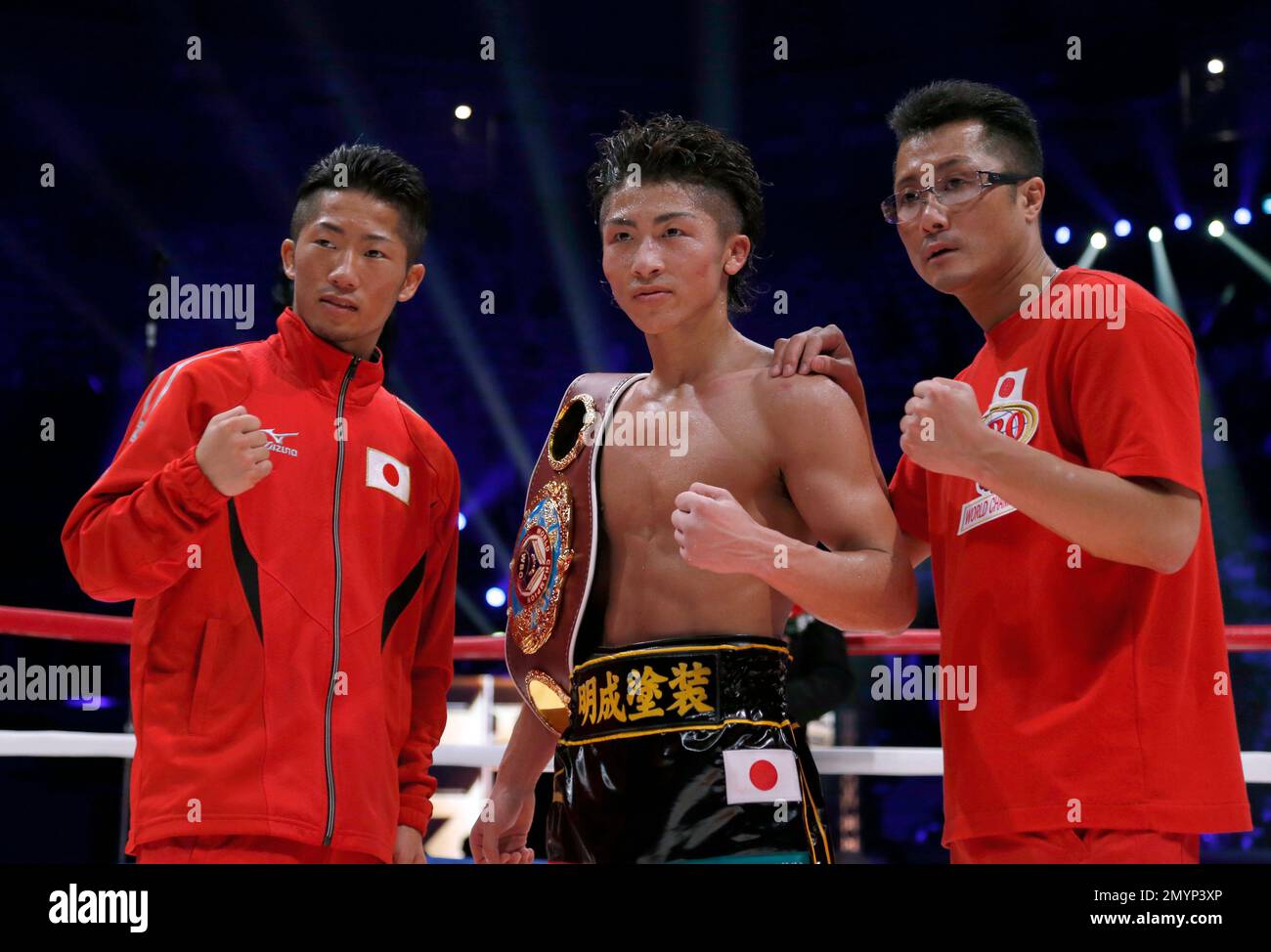 Japanese champion Naoya Inoue holding his belt poses for photographers ...