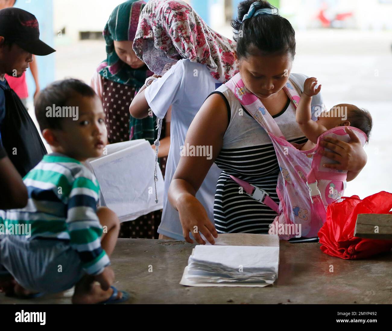 Filipino Muslims check their names and their polling precincts a day ...