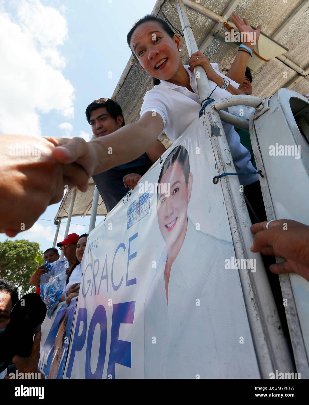 Presidential candidate Sen. Grace Poe shakes hands with supporters during her campaign around ...