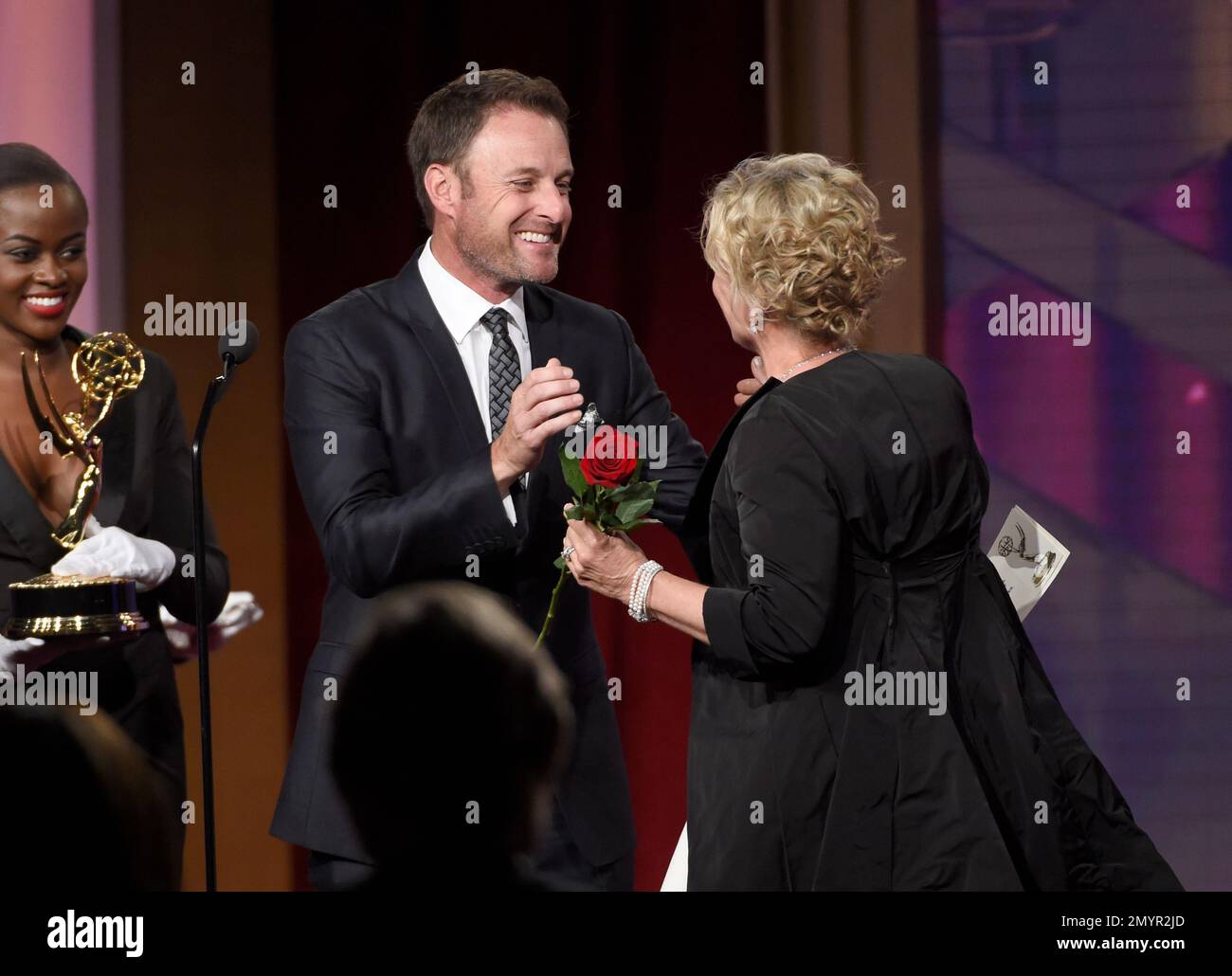 Chris Harrison, left, presents Mary Beth with the award for outstanding ...
