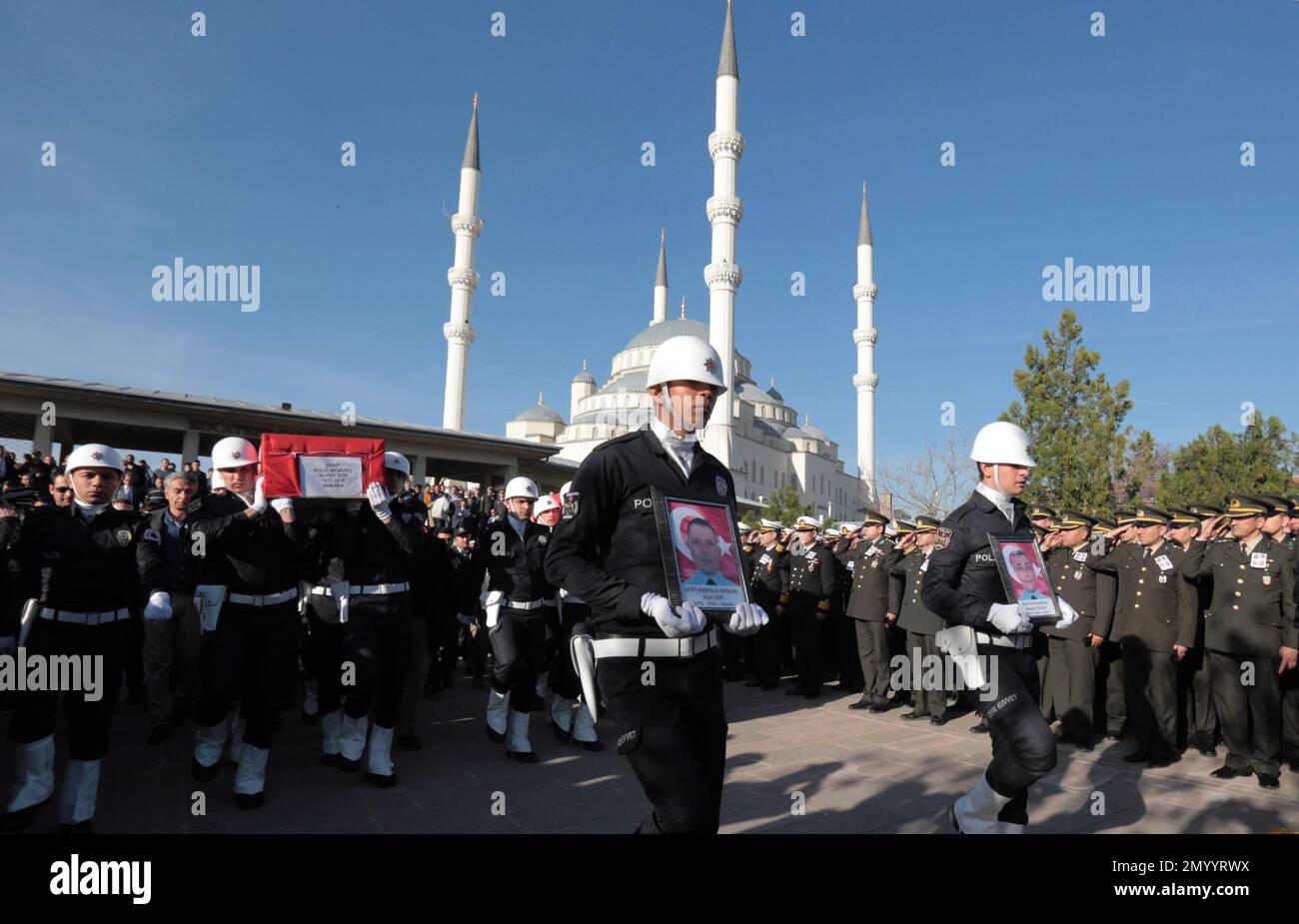 Turkish army officers salute as police officers carry the coffins of ...