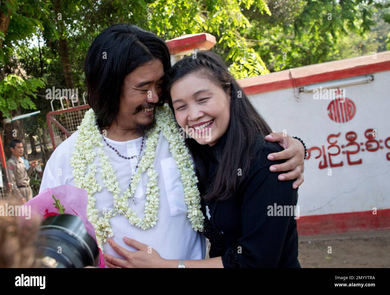 Ethnic Kachin activist Patrick Kum Ja Lee, left, poses for pictures with his wife and prominent ...