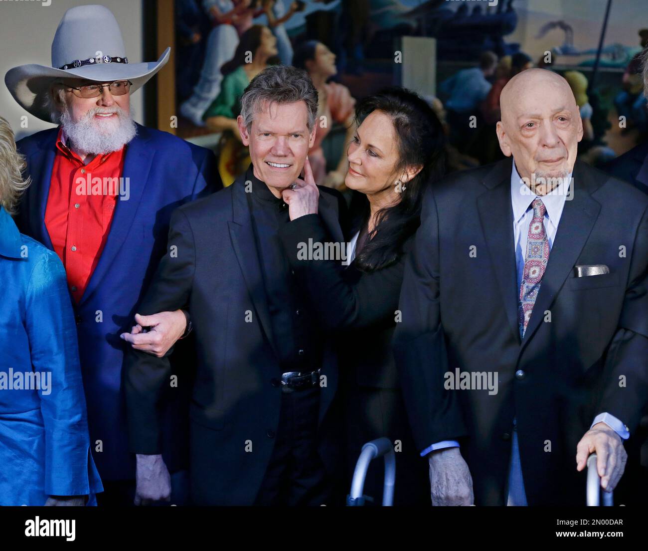 Country music singer Randy Travis, second from left, is joined by his ...