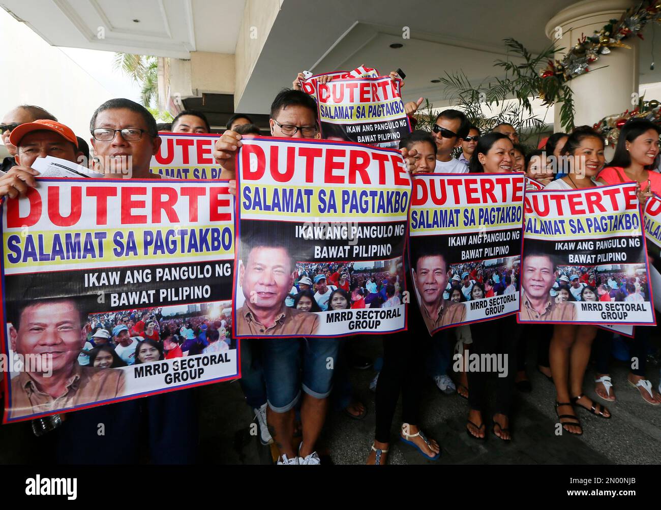 In this Nov.30, 2015 photo, supporters display campaign posters during ...