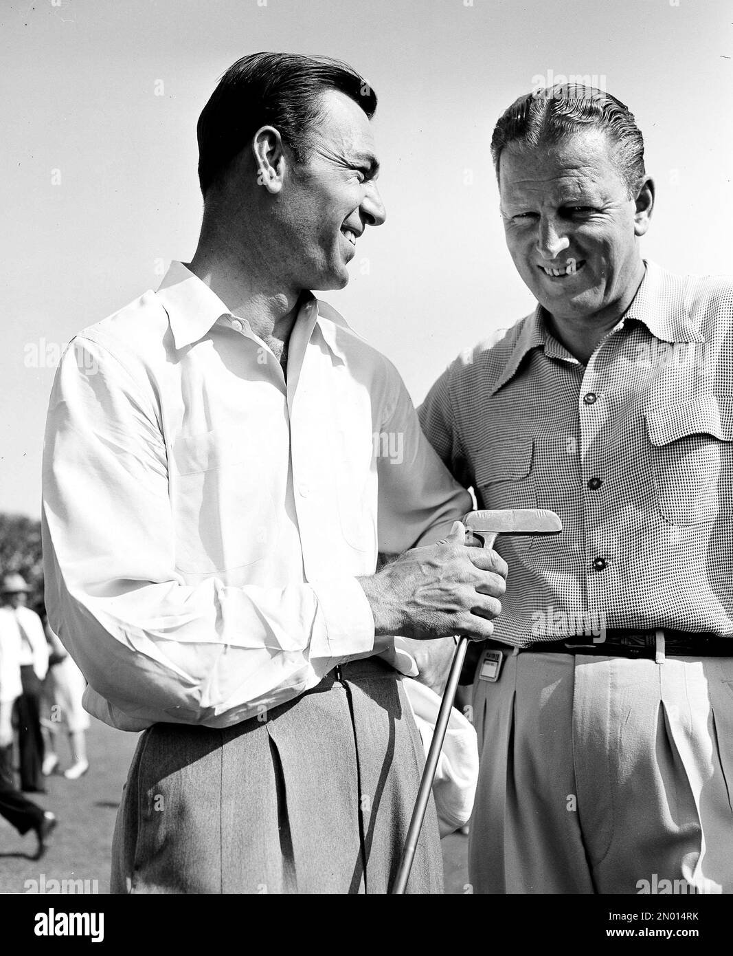 Ben Hogan, left, shows Craig Wood, right, a favorite putter he hopes to ...