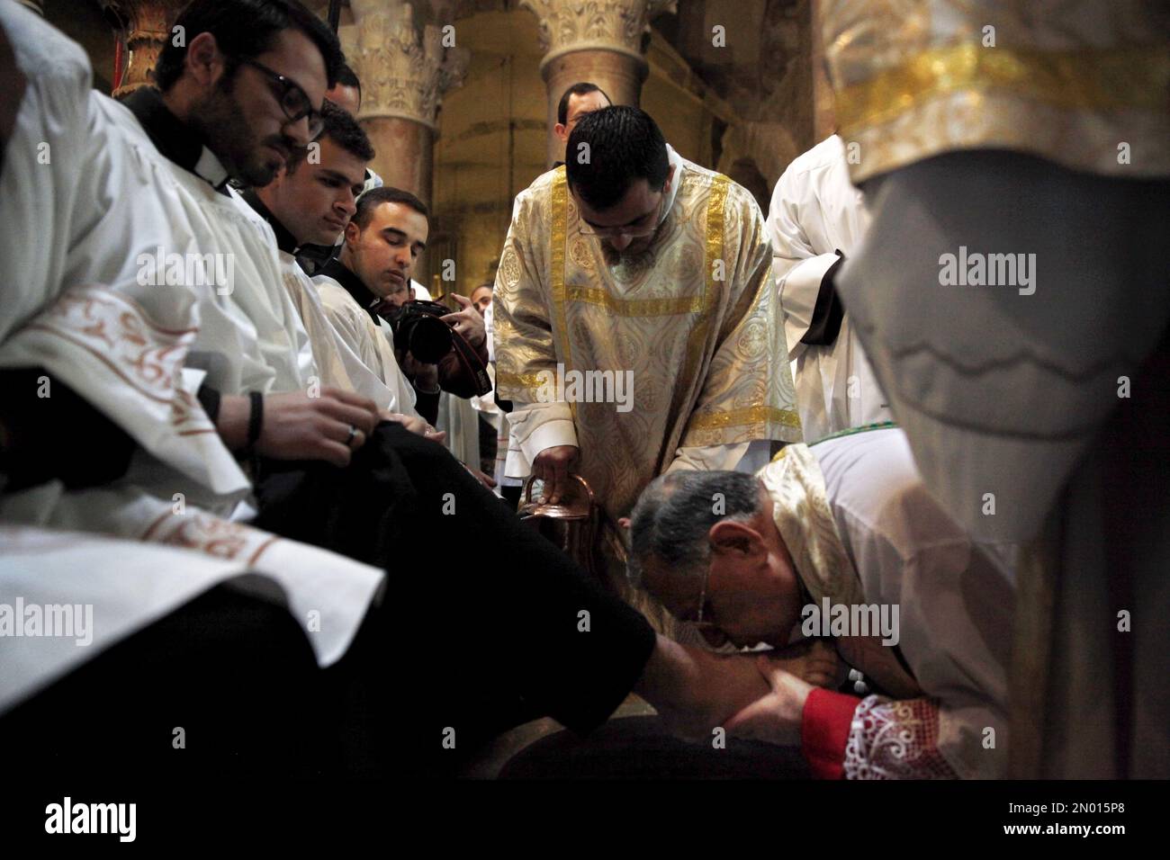 Latin Patriarch of Jerusalem, Fouad Twal, right, kisses a clergymen's ...