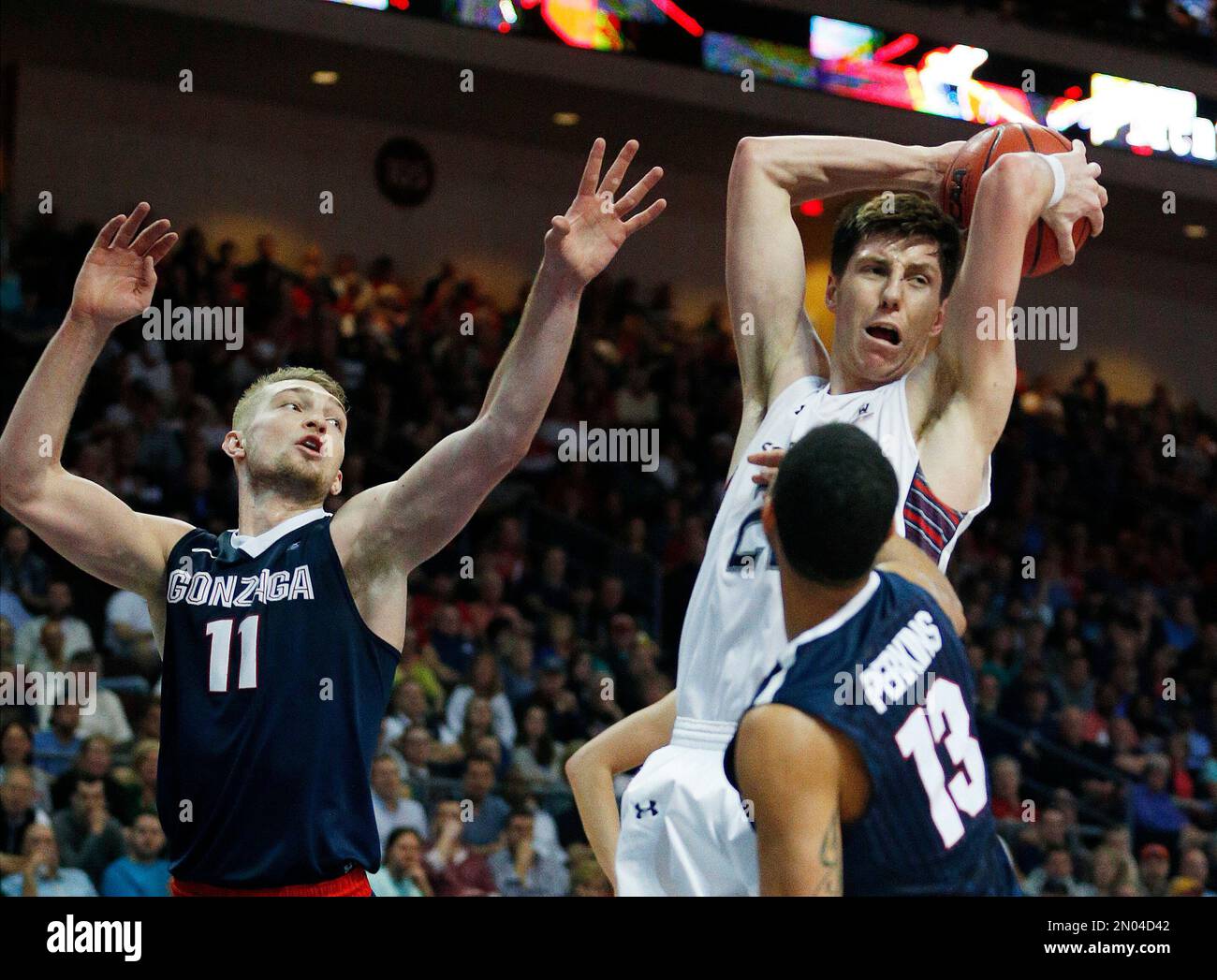 Saint Mary's forward Dane Pineau, right, grabs a rebound over Gonzaga forward Domantas Sabonis ...