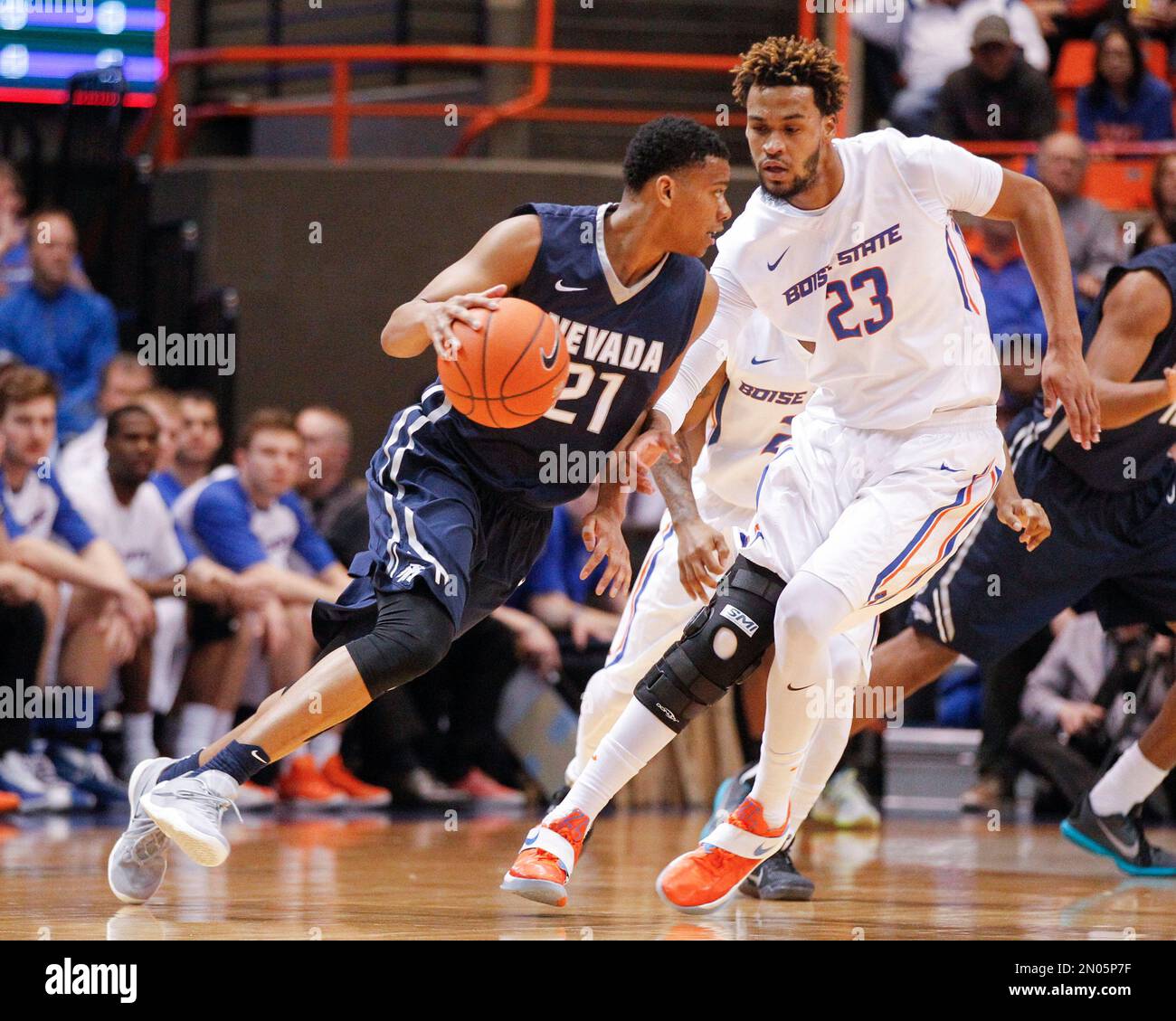 Nevada's Eric Cooper Jr (21) moves the ball around Boise State's James ...