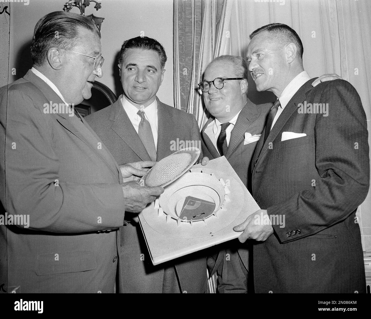 Brooklyn Dodgers president Walter O'Malley lifts a small scale plastic ...