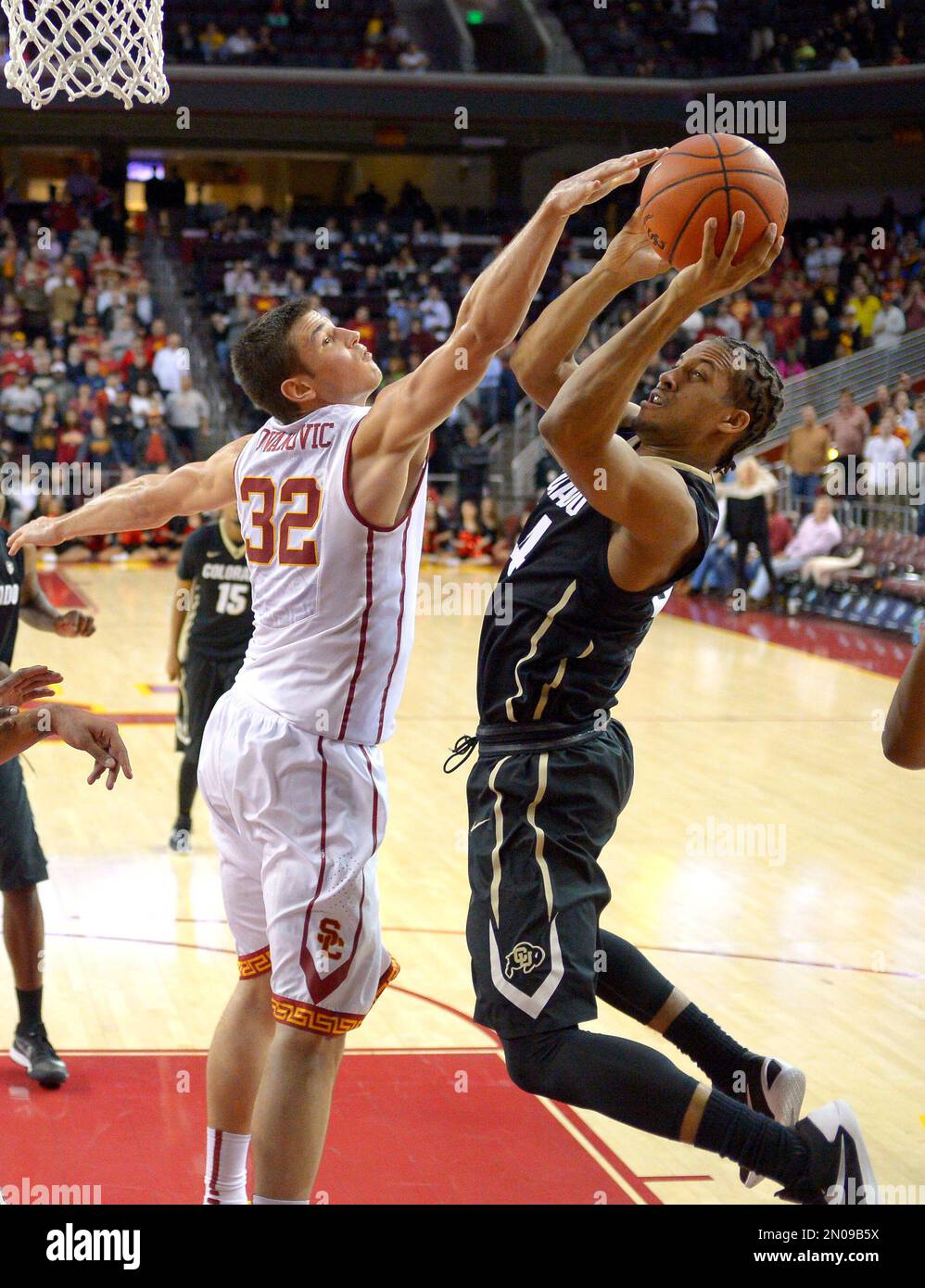Colorado guard Josh Fortune, right, shoots as Southern California ...