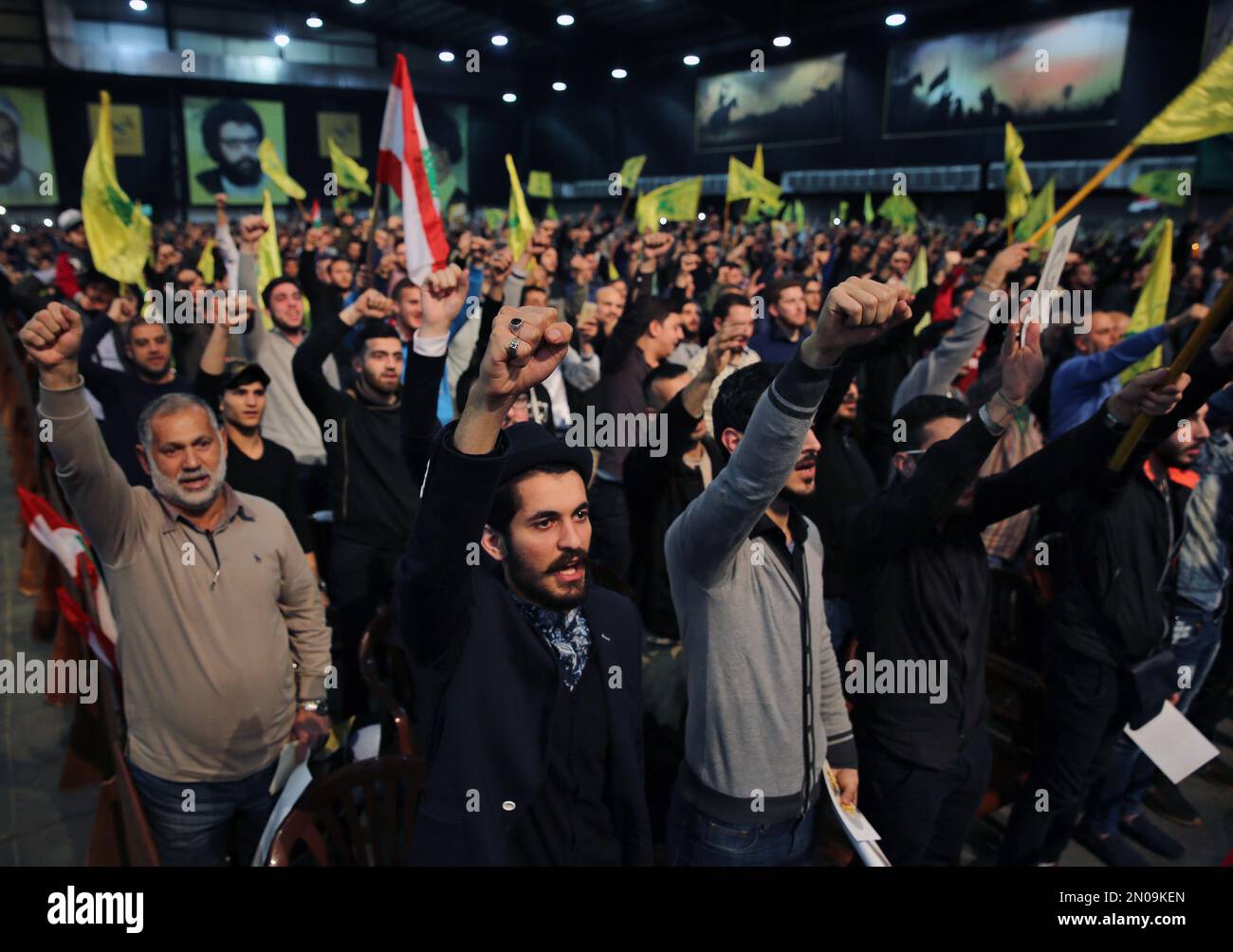 Hezbollah supporters cheer as they listen to a speech by Hezbollah ...