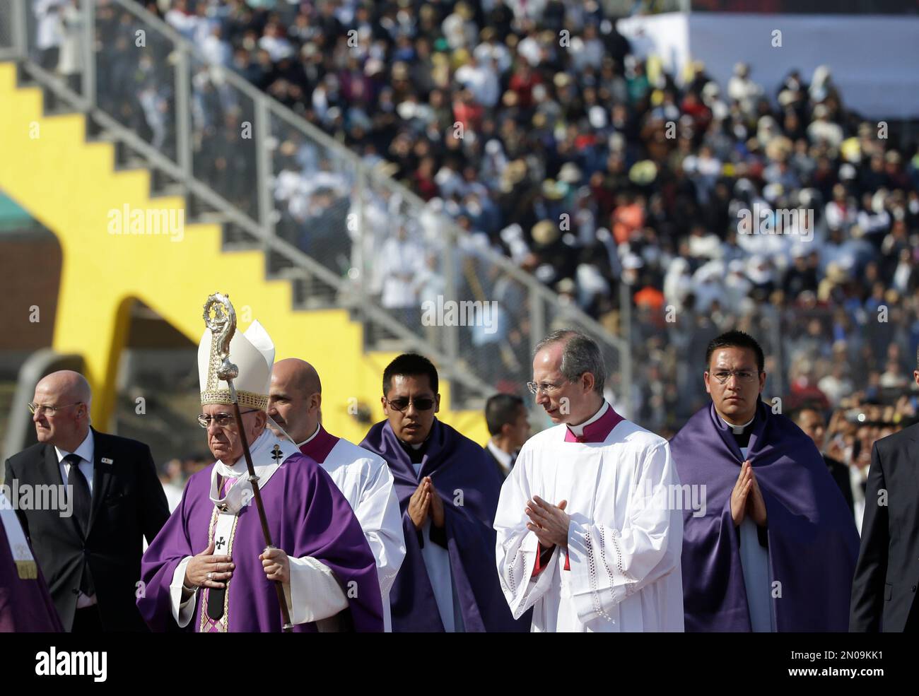 Pope Francis walks in procession at a stadium before celebrating Mass ...