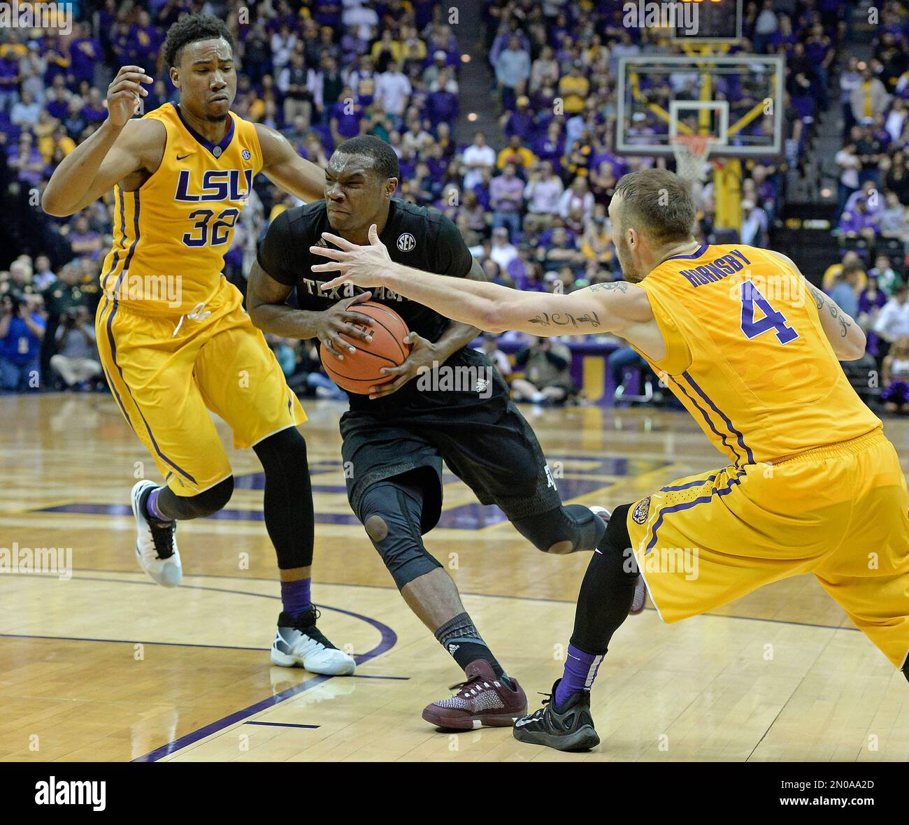 Texas A&M forward Jalen Jones (12) drives to the basket between LSU ...