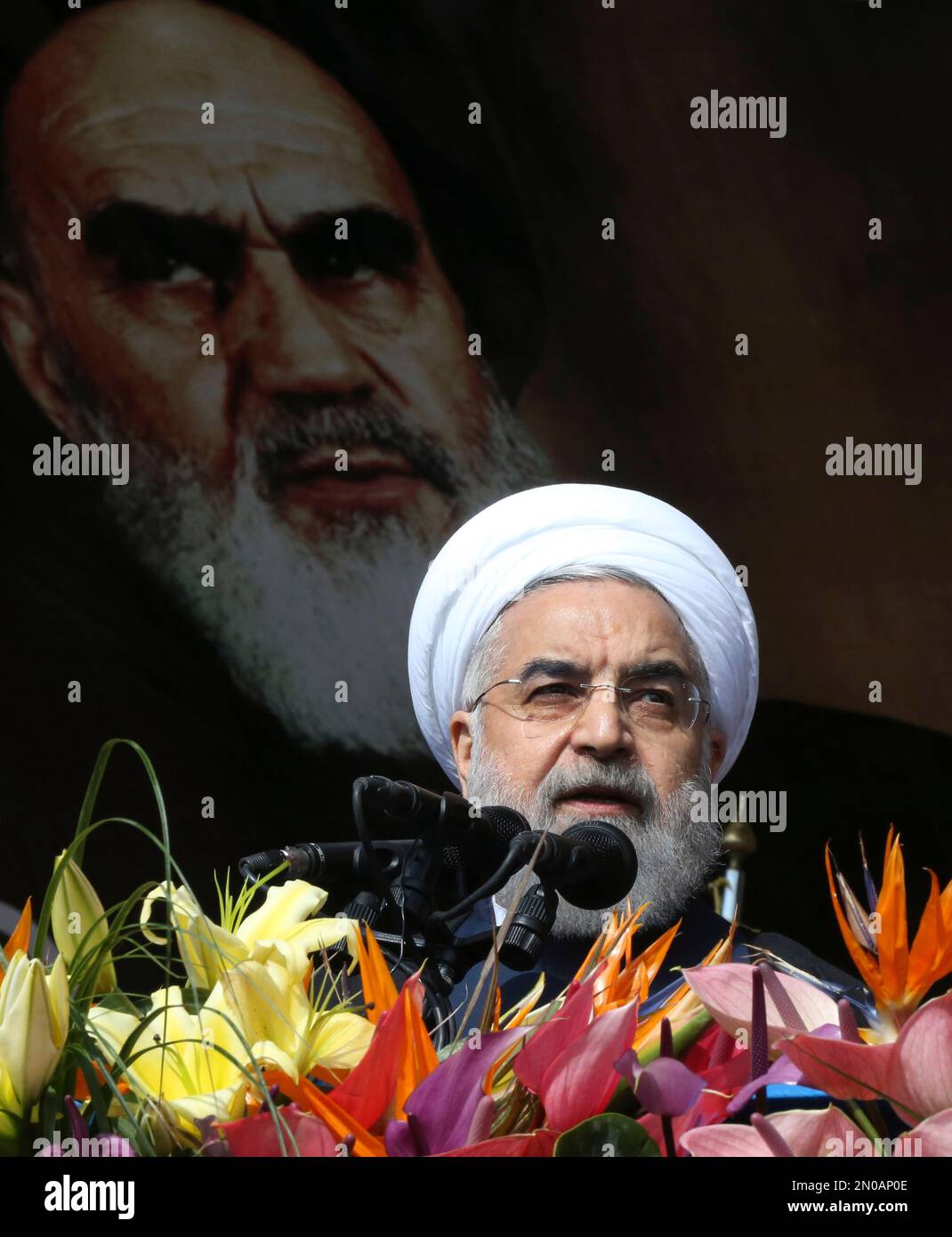 Iranian President Hassan Rouhani delivers his speech under a portrait ...