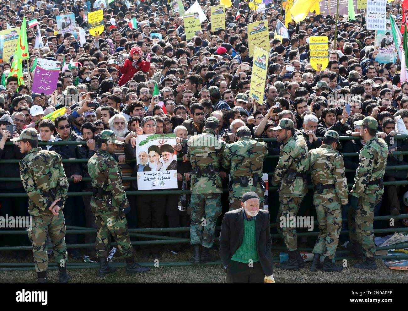Iranian police officers stand in front of the crowd controlling the ...
