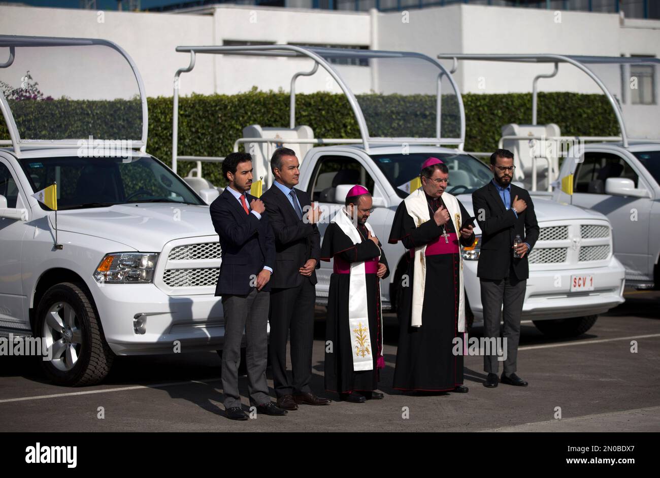 Partipants cross themselves as Papal Nuncio Christophe Pierre, second ...